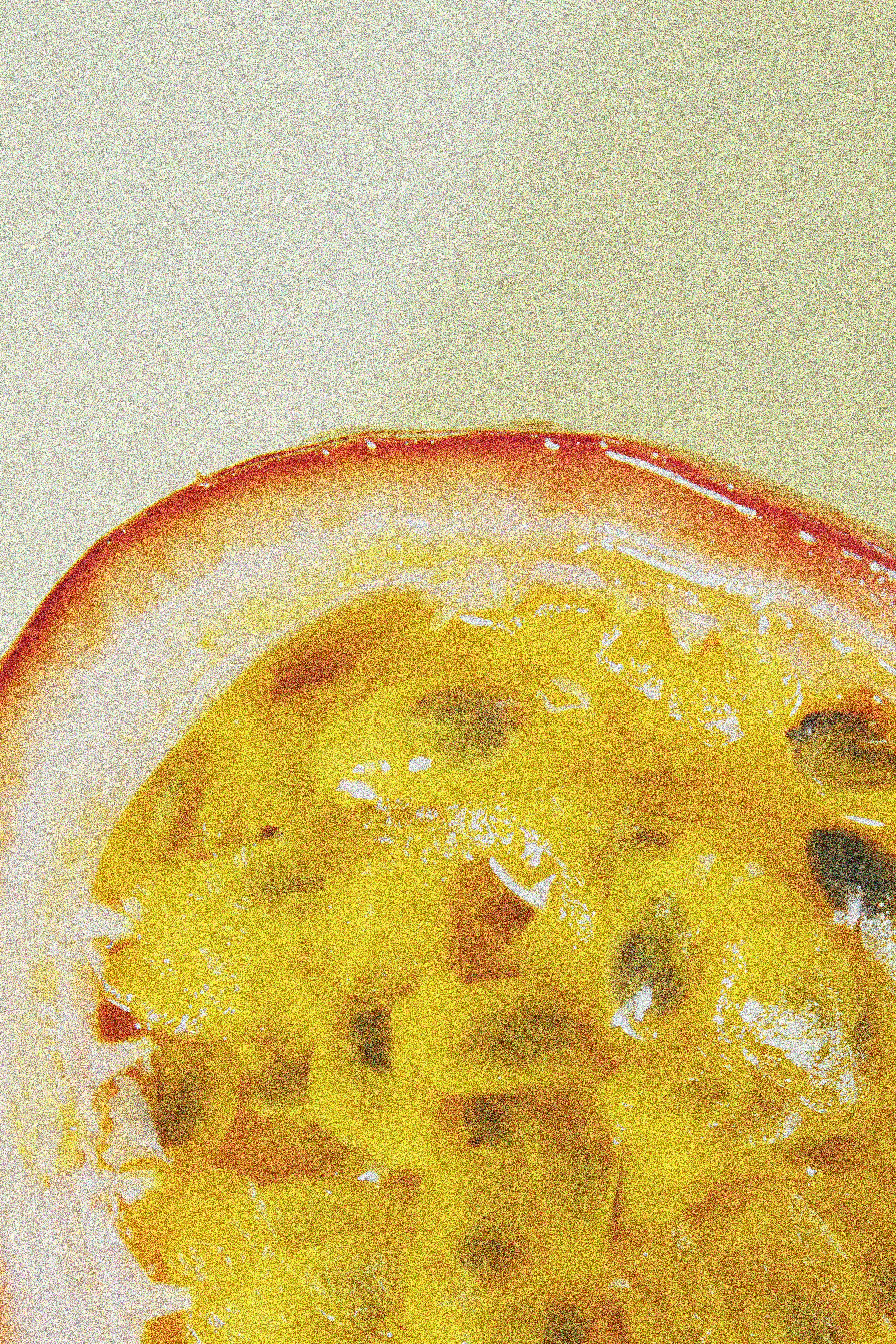 A half passion fruit shows its juicy interior.