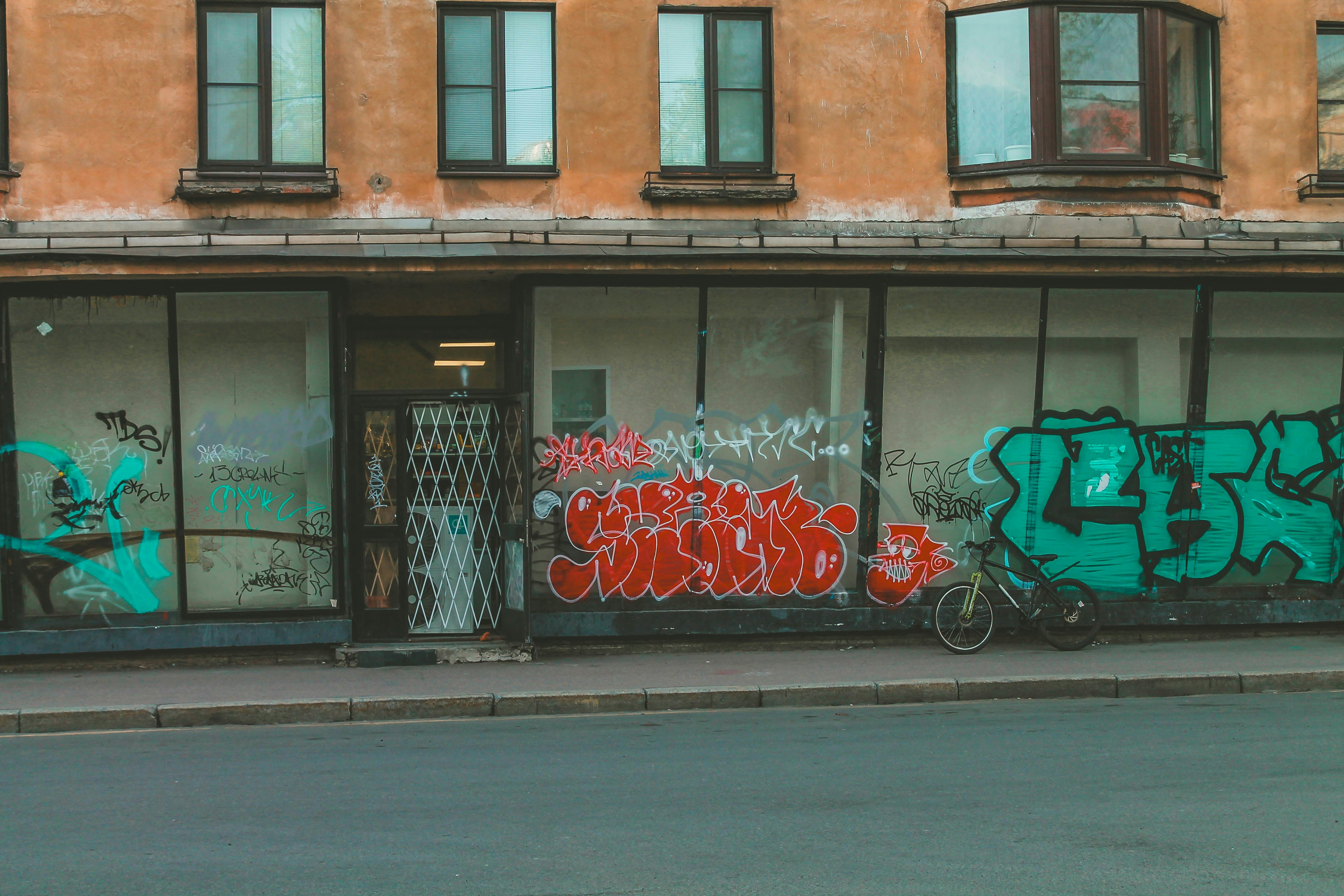 Graffiti covers a building's storefront. photo – Free City Image on ...