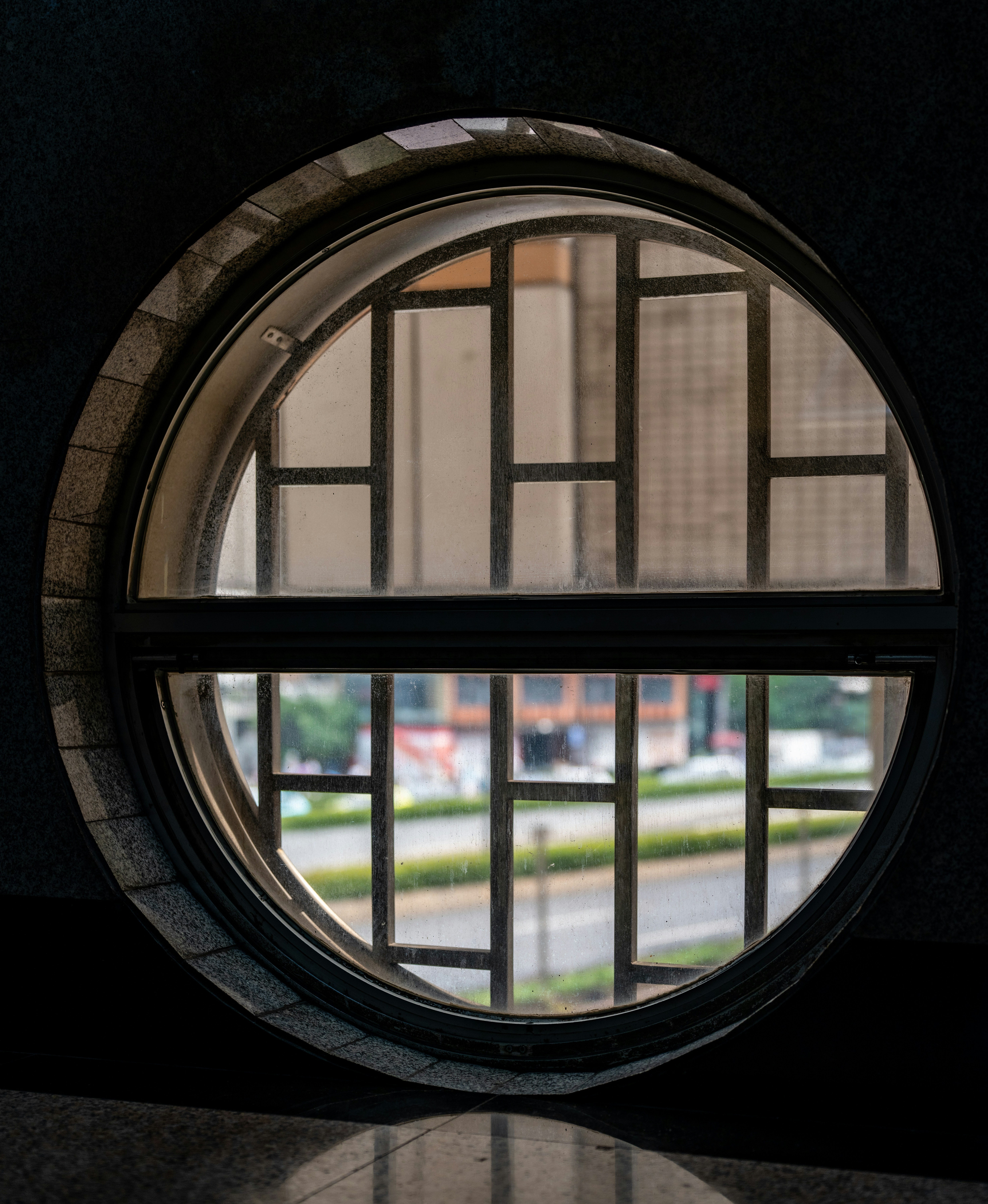 A round window frames city views with bars. photo – Free Wall Image on ...
