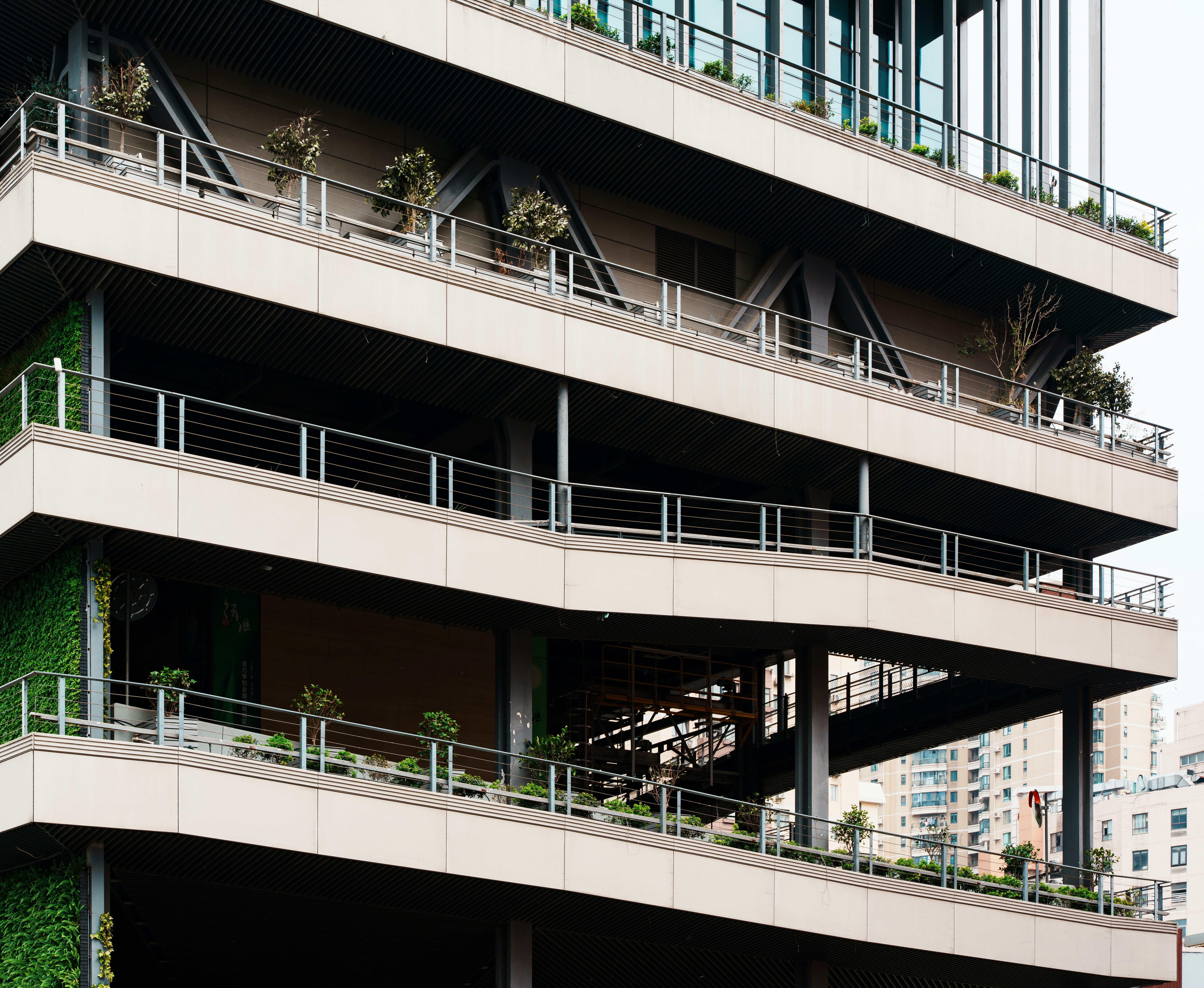 Tiered Terraces: Greenery Cascades Across a Modern Urban Facade