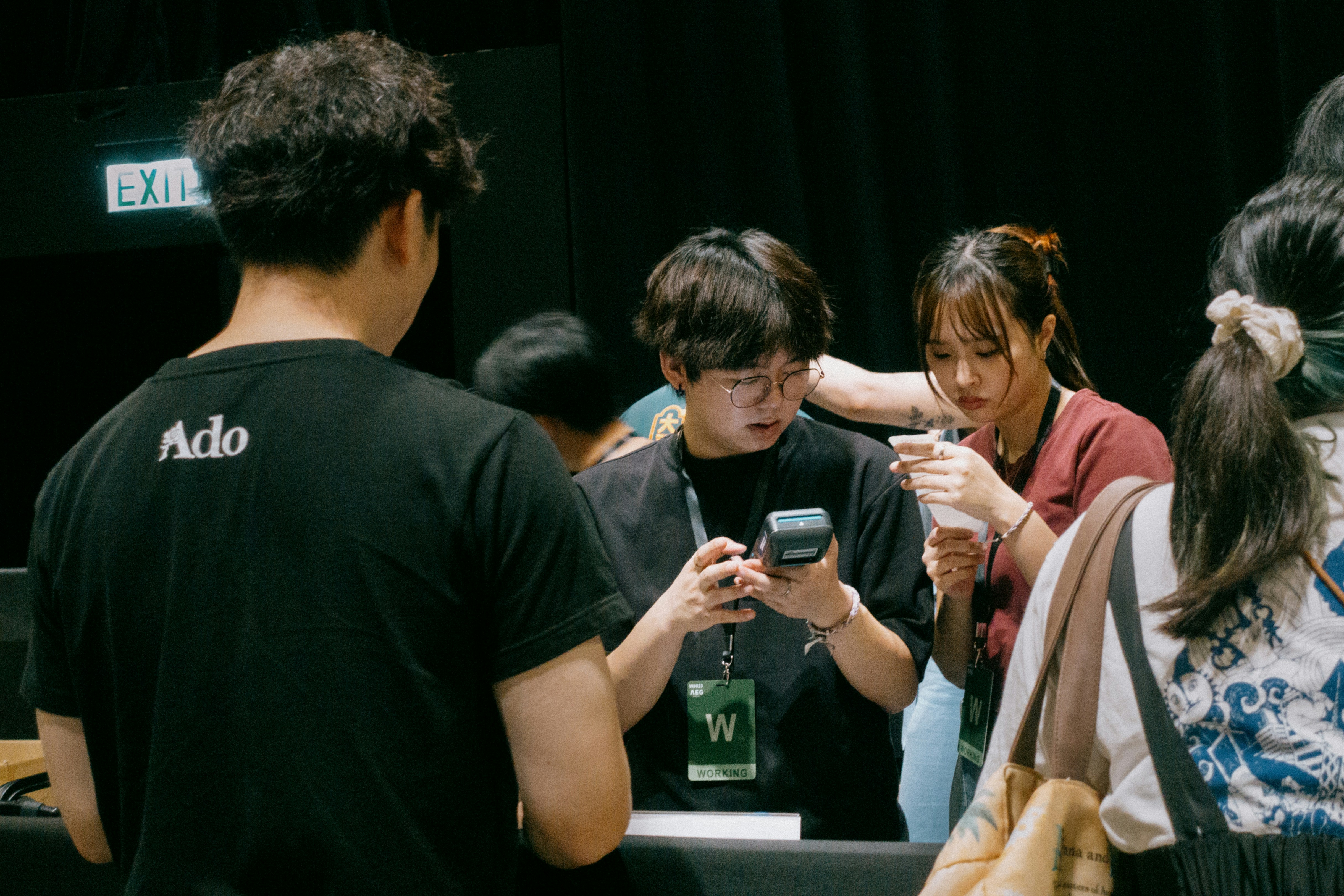 People are checking tickets at an event. photo – Free People Image on ...