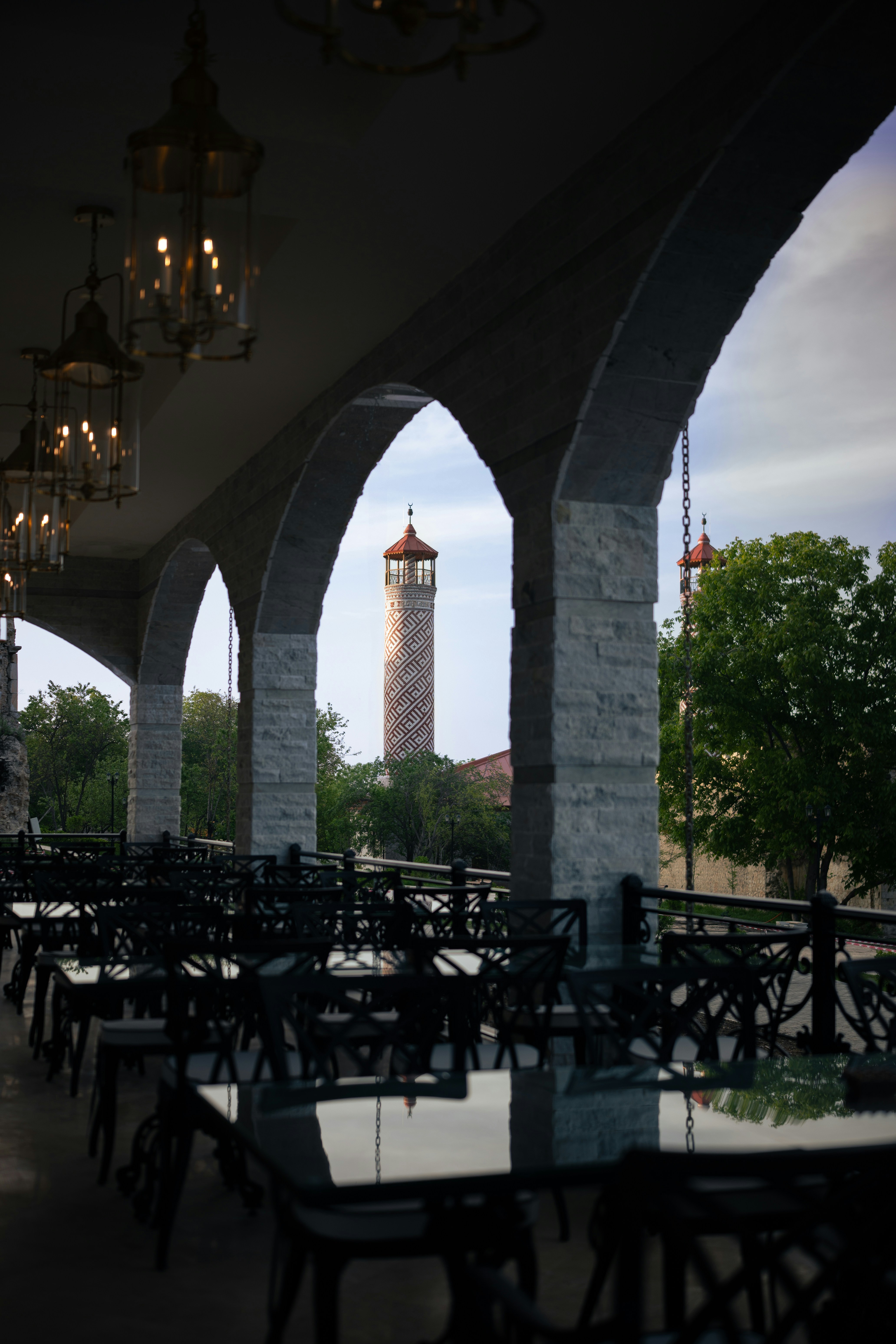 Arches and a Diamond‑Patterned Tower: Framing Depth from a Veranda