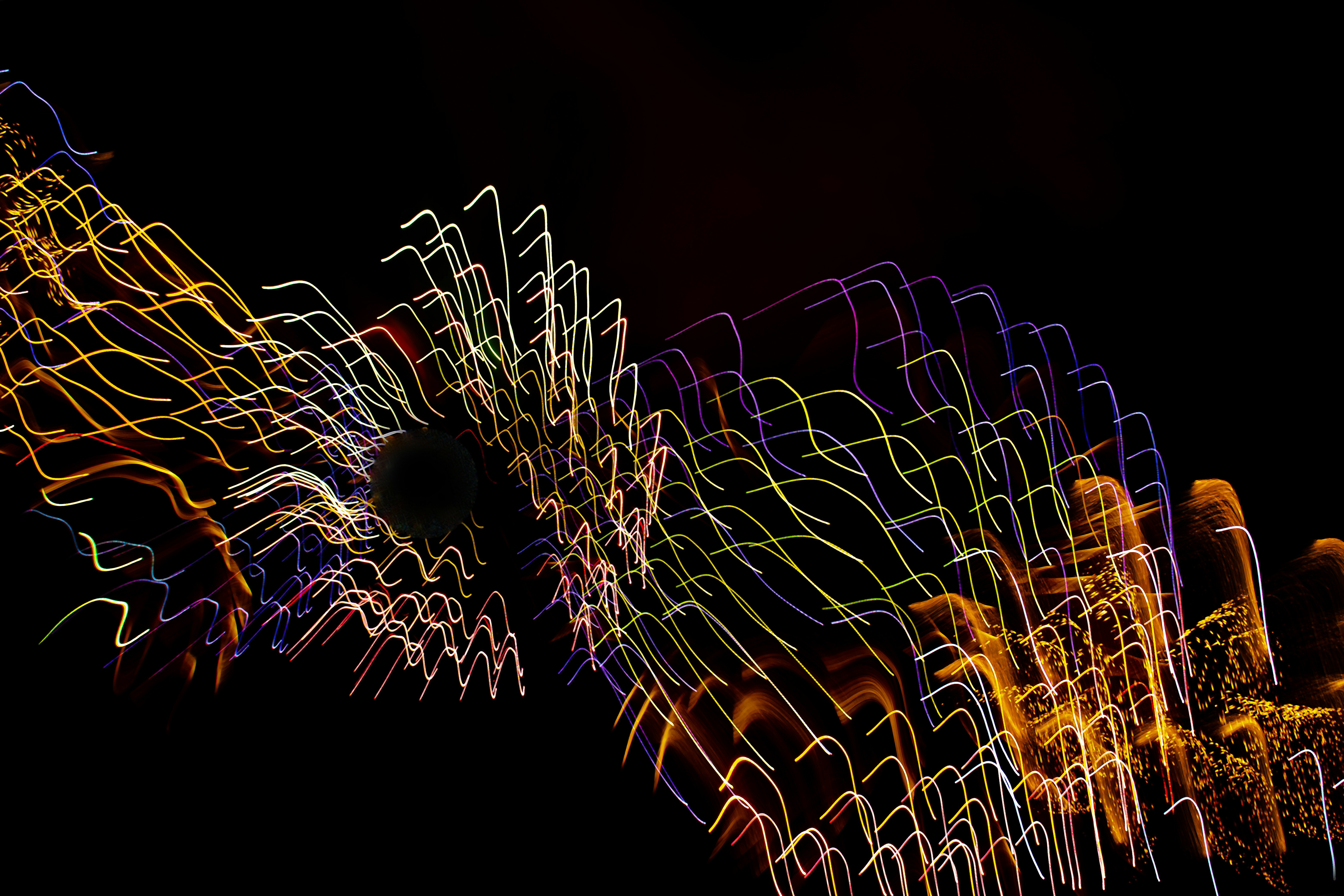 Fireworks create colorful, abstract light trails.