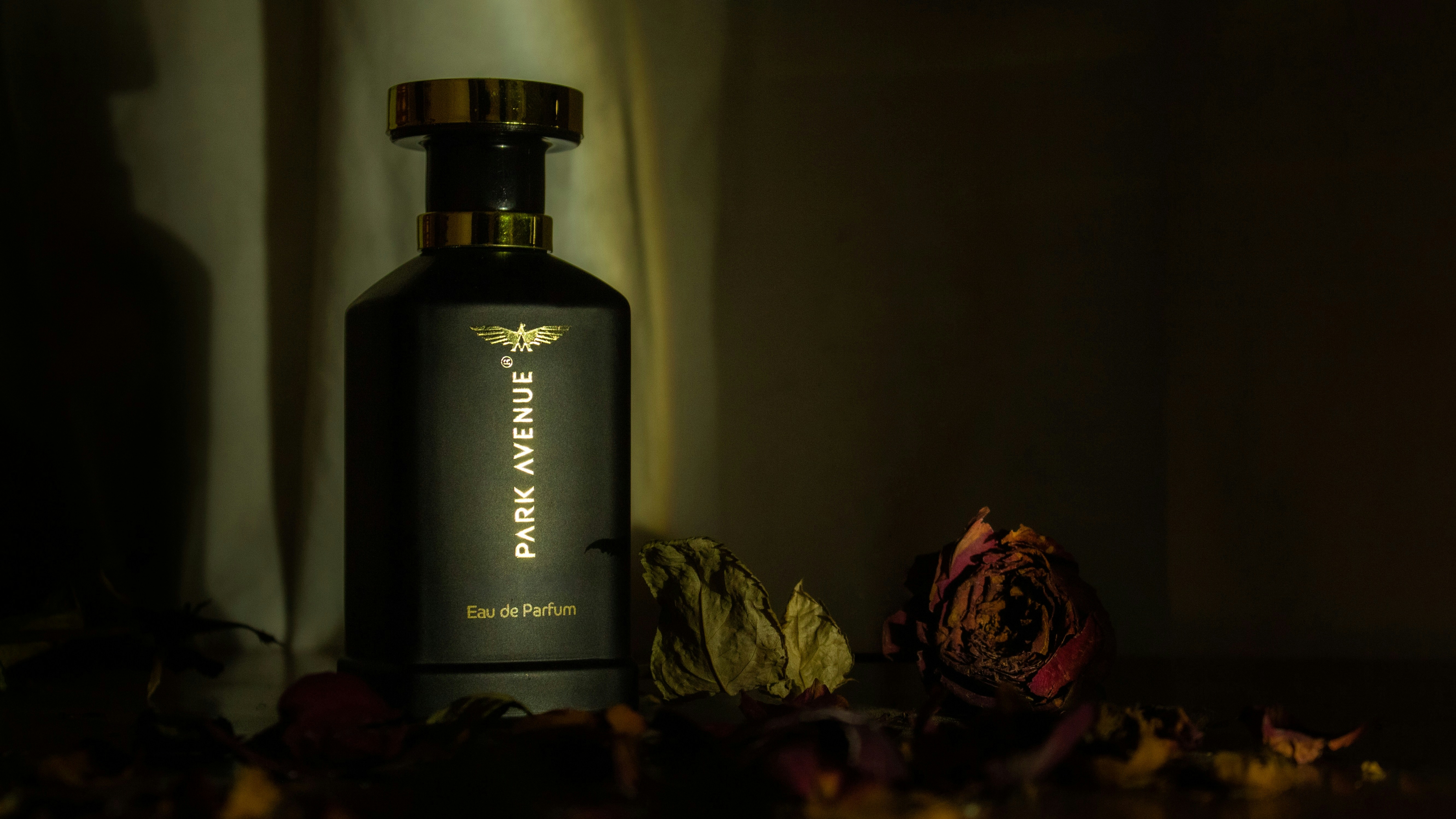 A darkly lit bottle of park avenue perfume. photo – Free Flowers Image ...