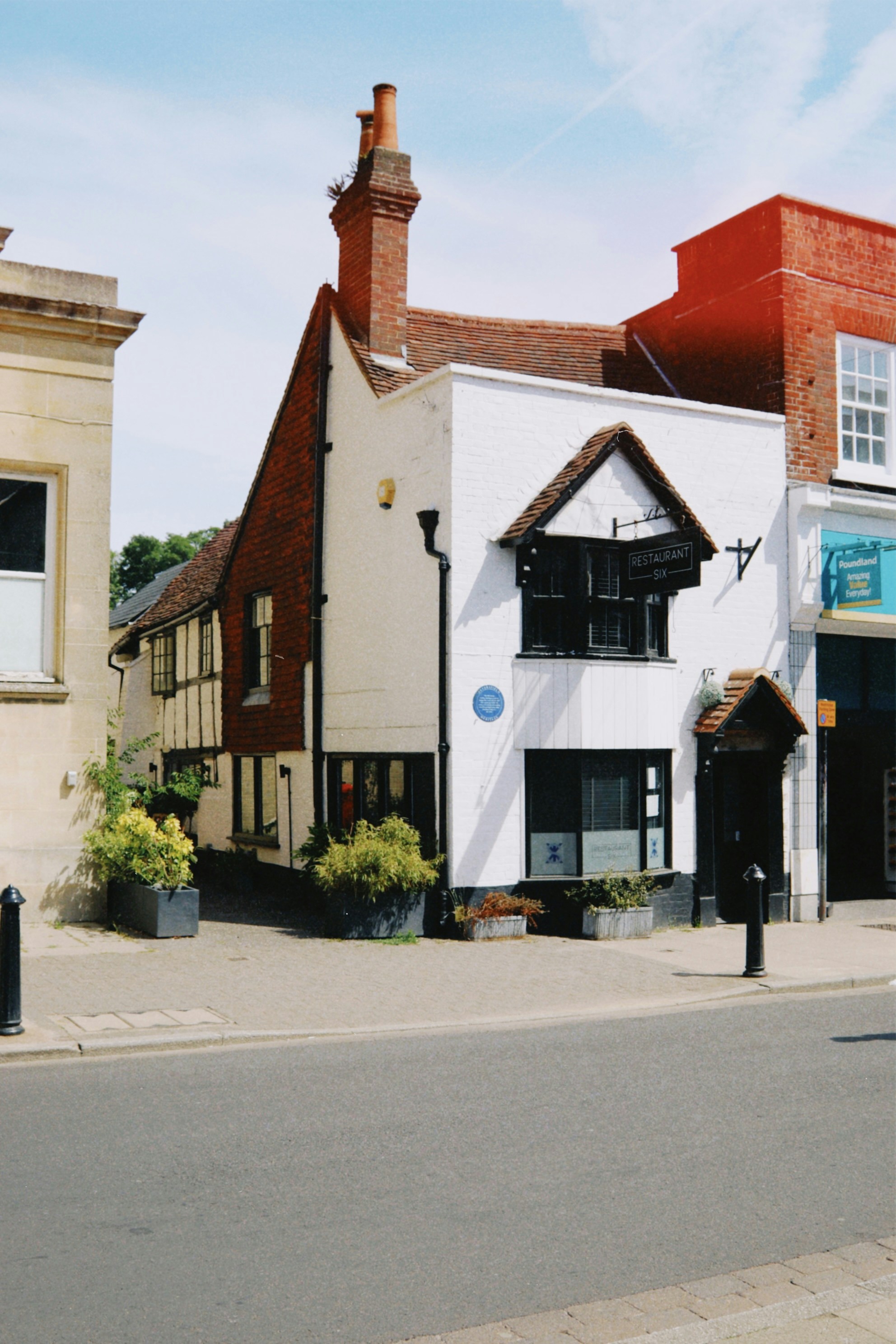 A unique white building sits on a street. photo – Free City Image on ...