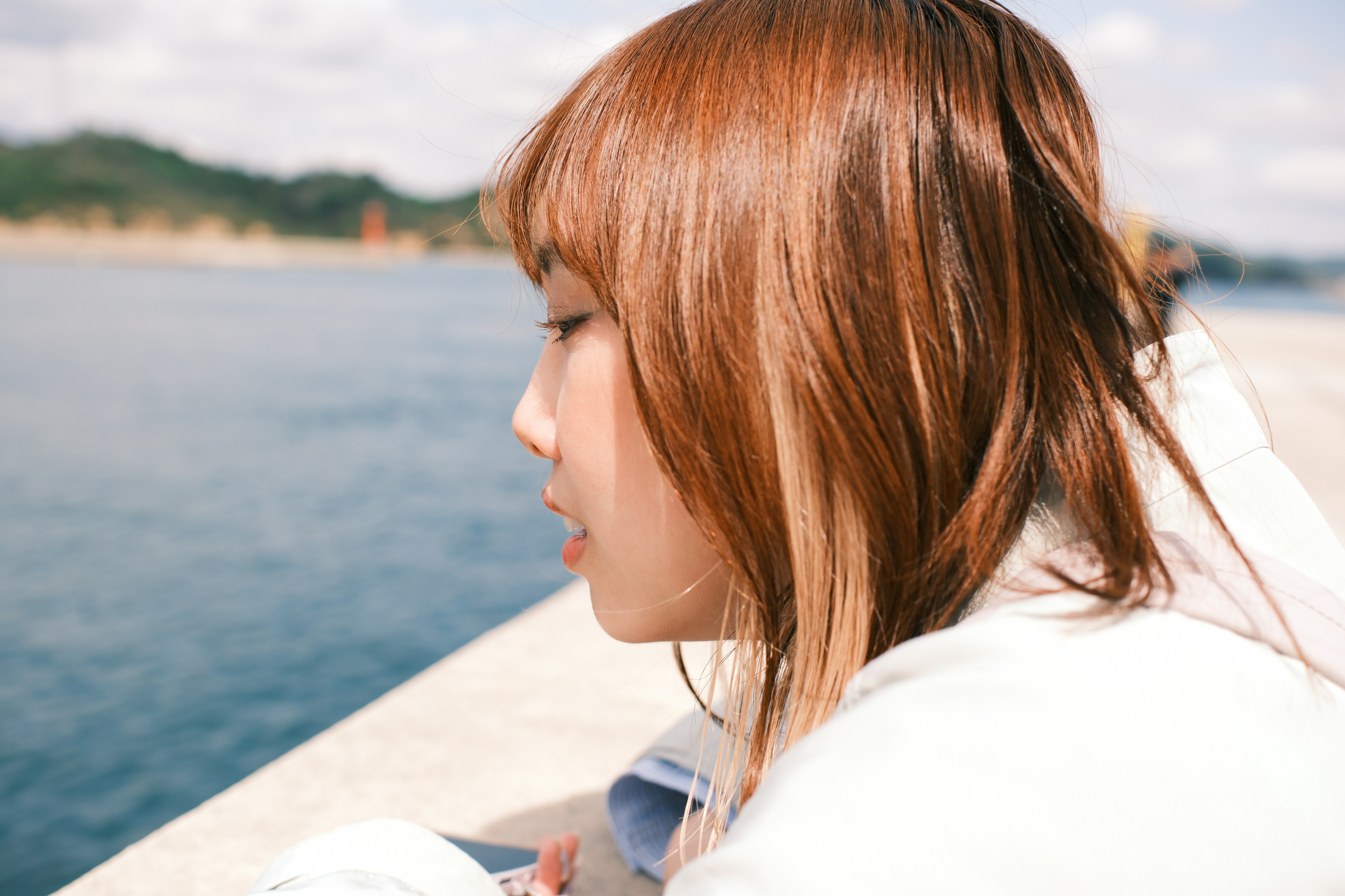Sunlit Profile by the Pier: A Quiet Moment on the Waterfront