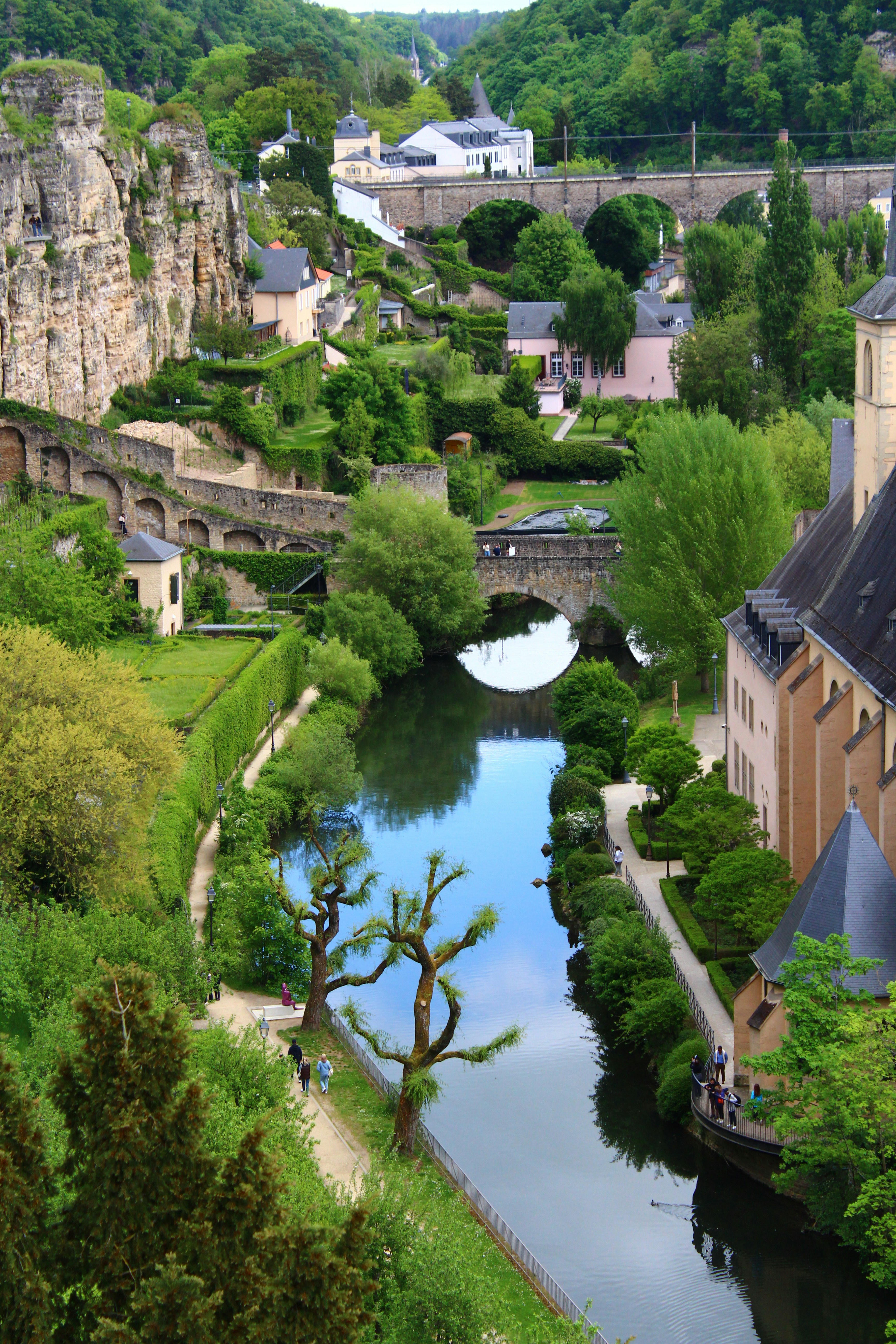 Arched Canal Vista: a hillside village framed by stone bridges and lush terraces