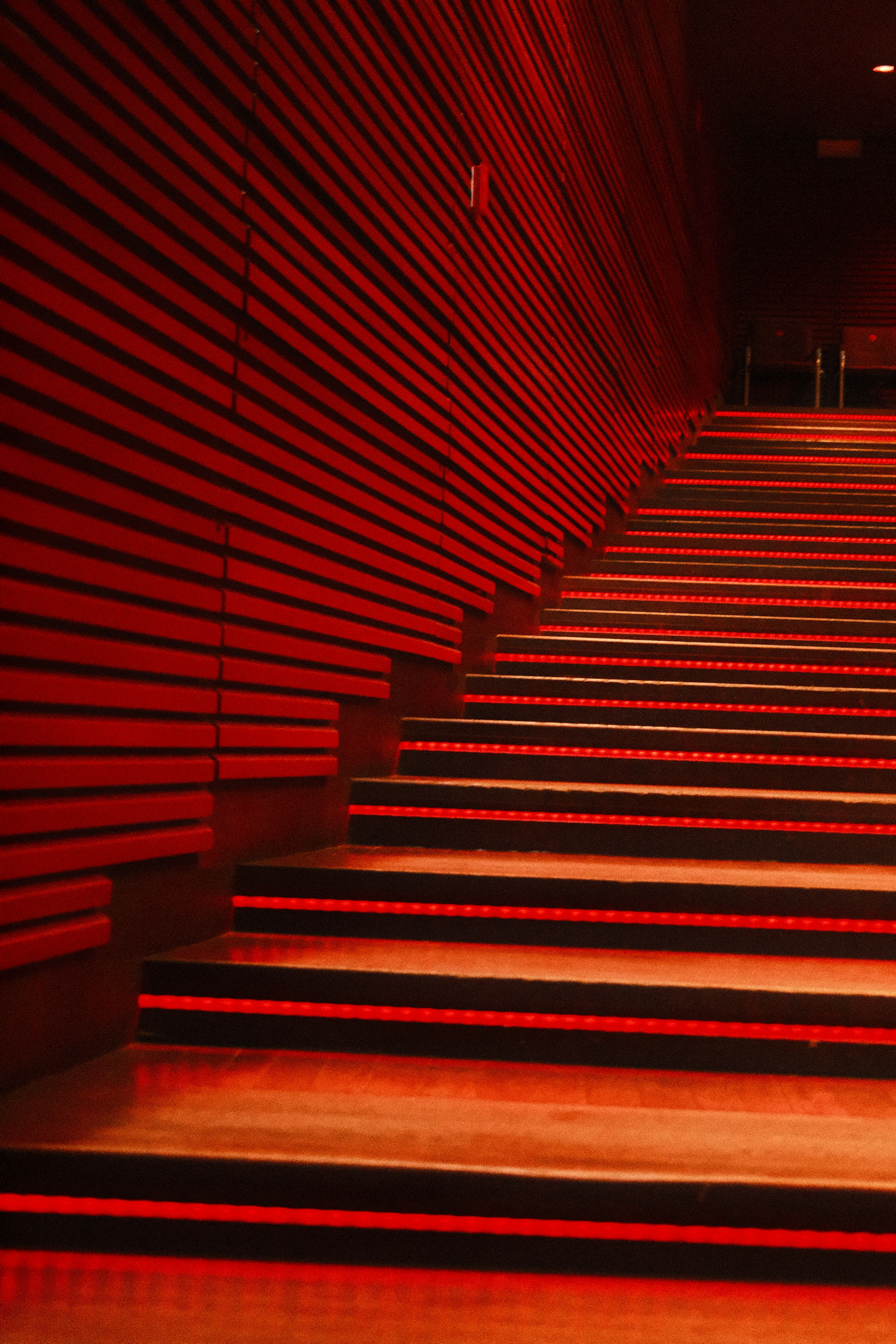Neon Geometry: Red Staircase Reaches for the Quiet Light