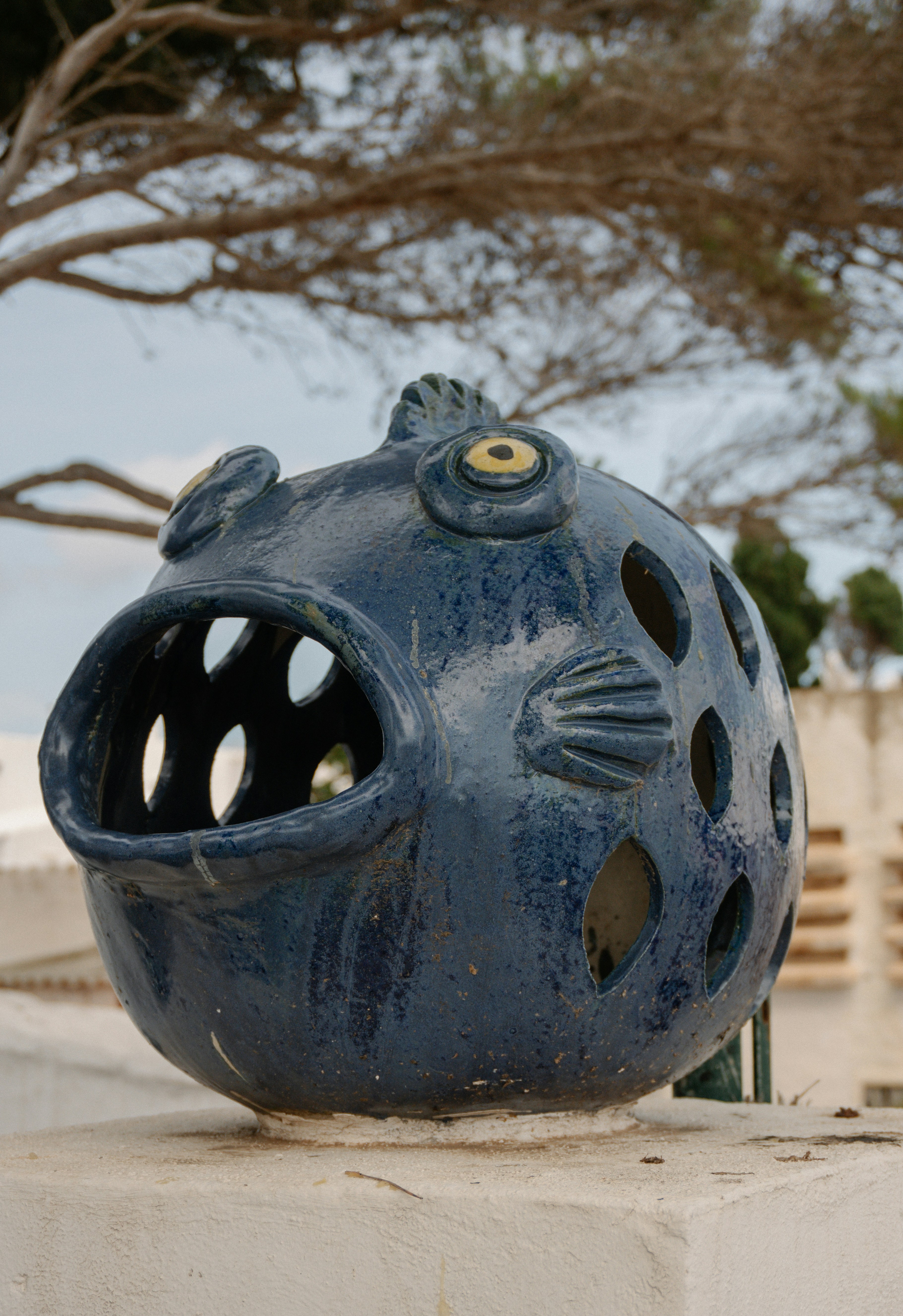 A ceramic fish sculpture with an open mouth.