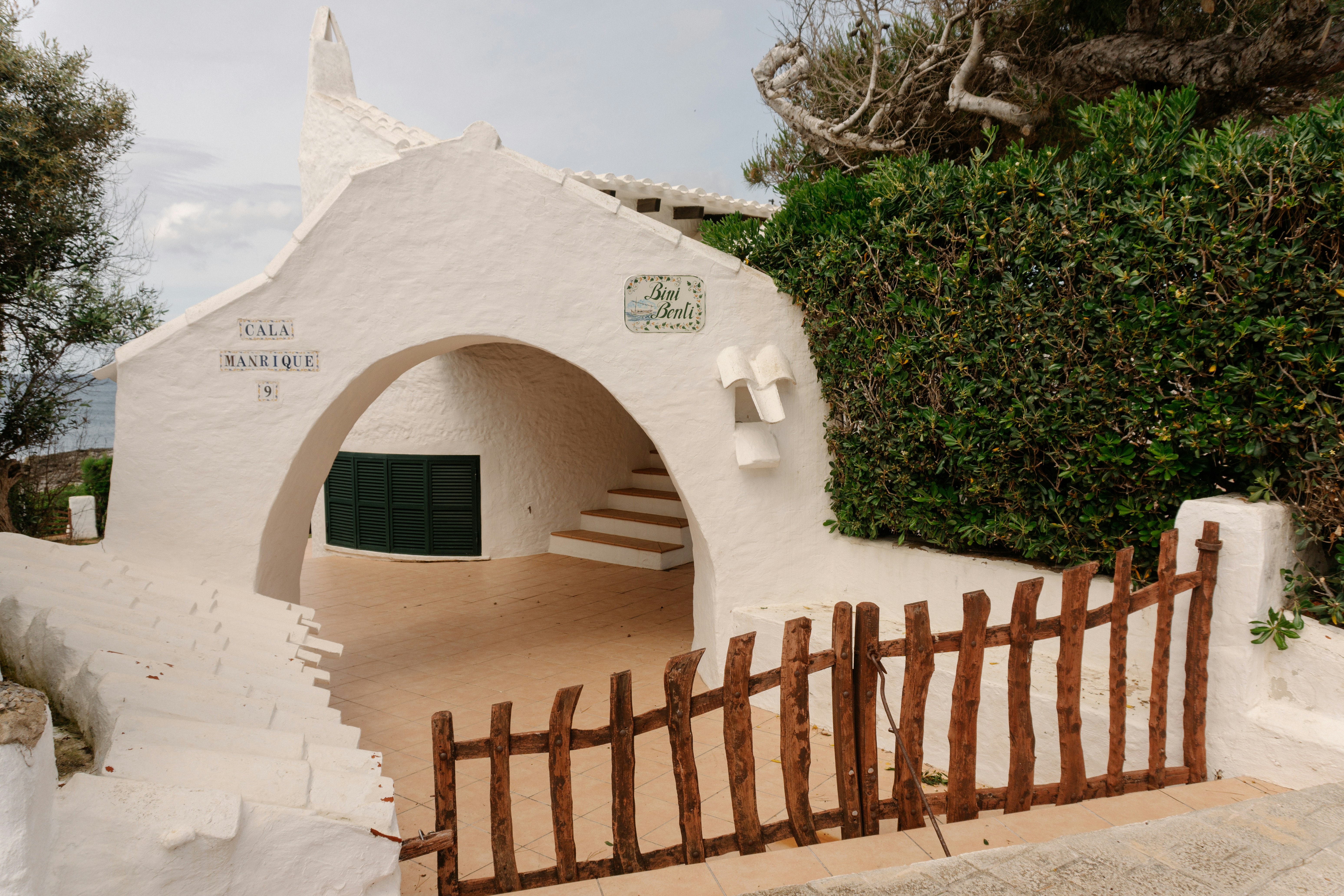 Whitewashed Cottage Gateway in Coastal Orchard