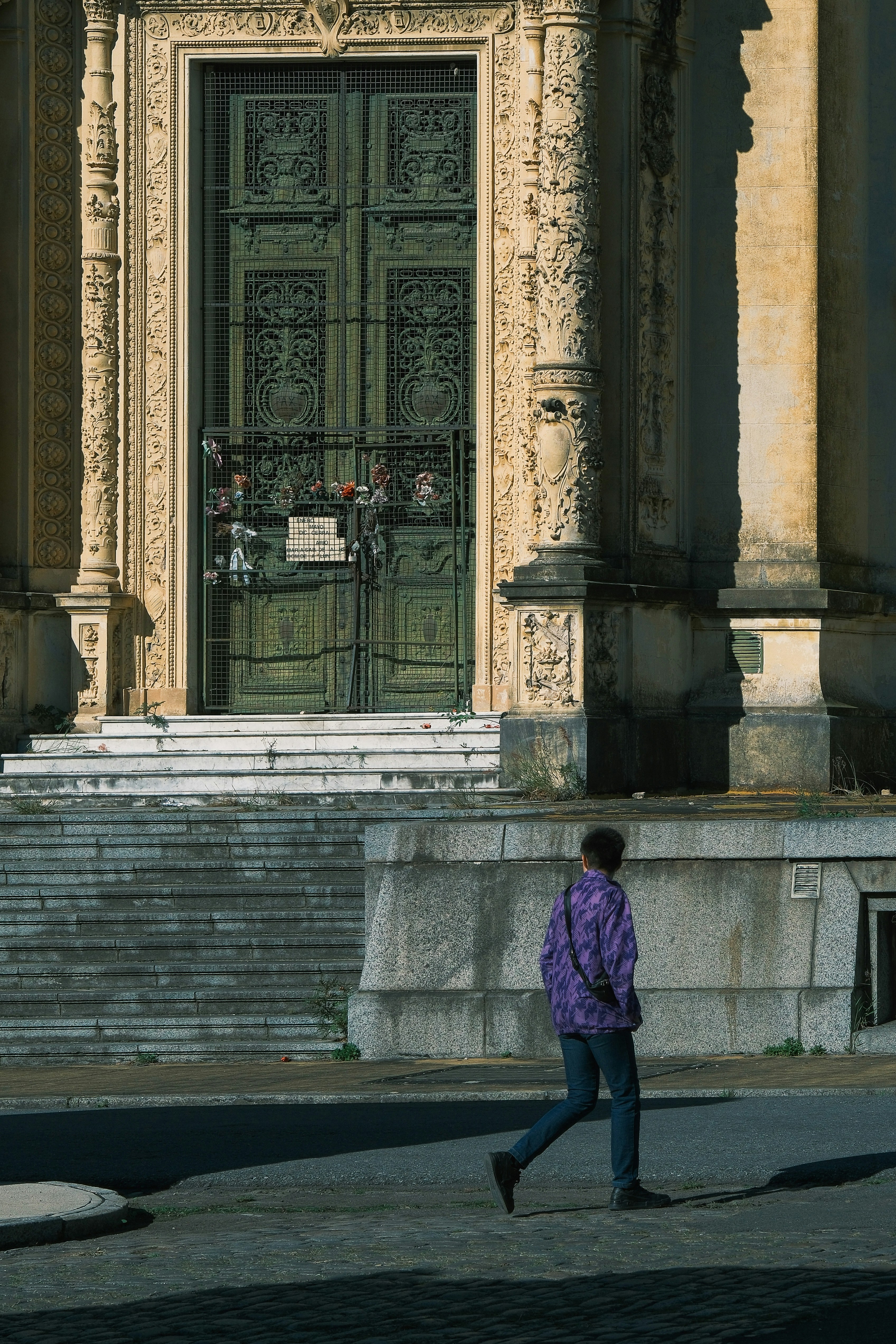 The Violet-Clad Traveler at a Carved Portal