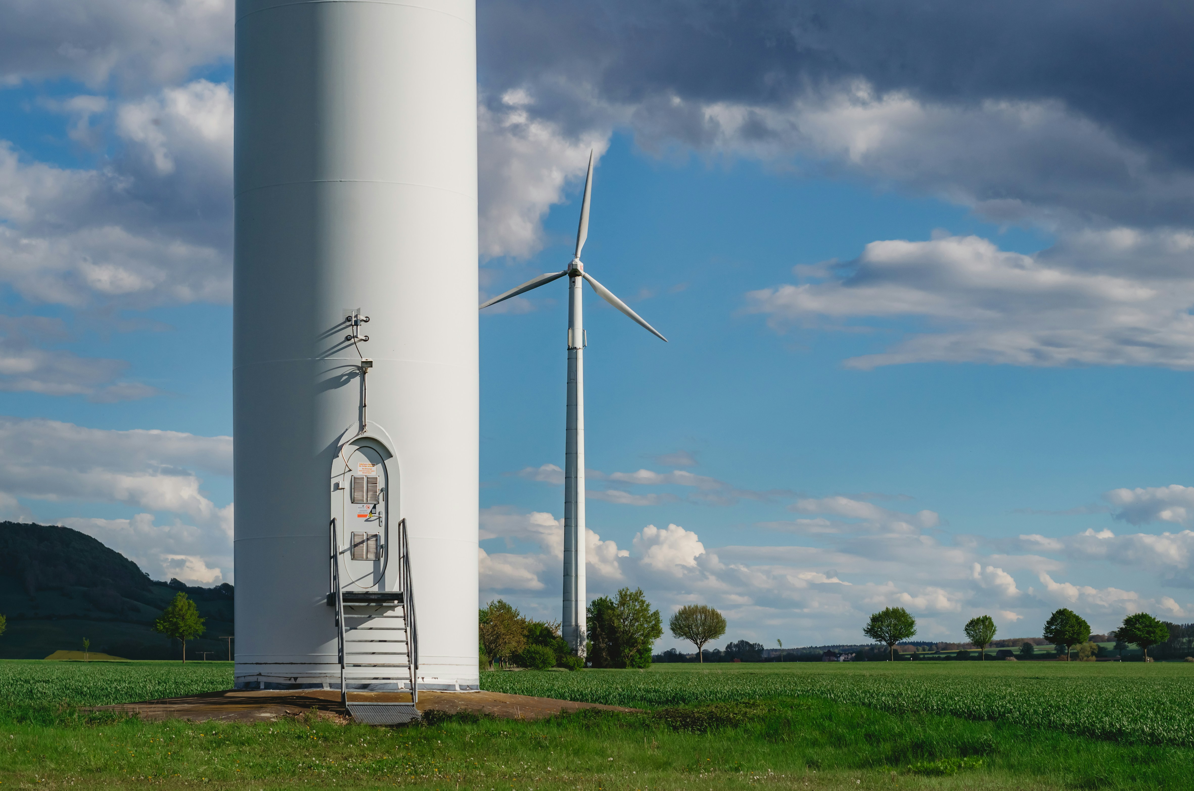 Wind turbines stand tall in a green field.