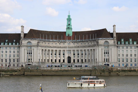 Neoclassical riverside facade under a pale sky