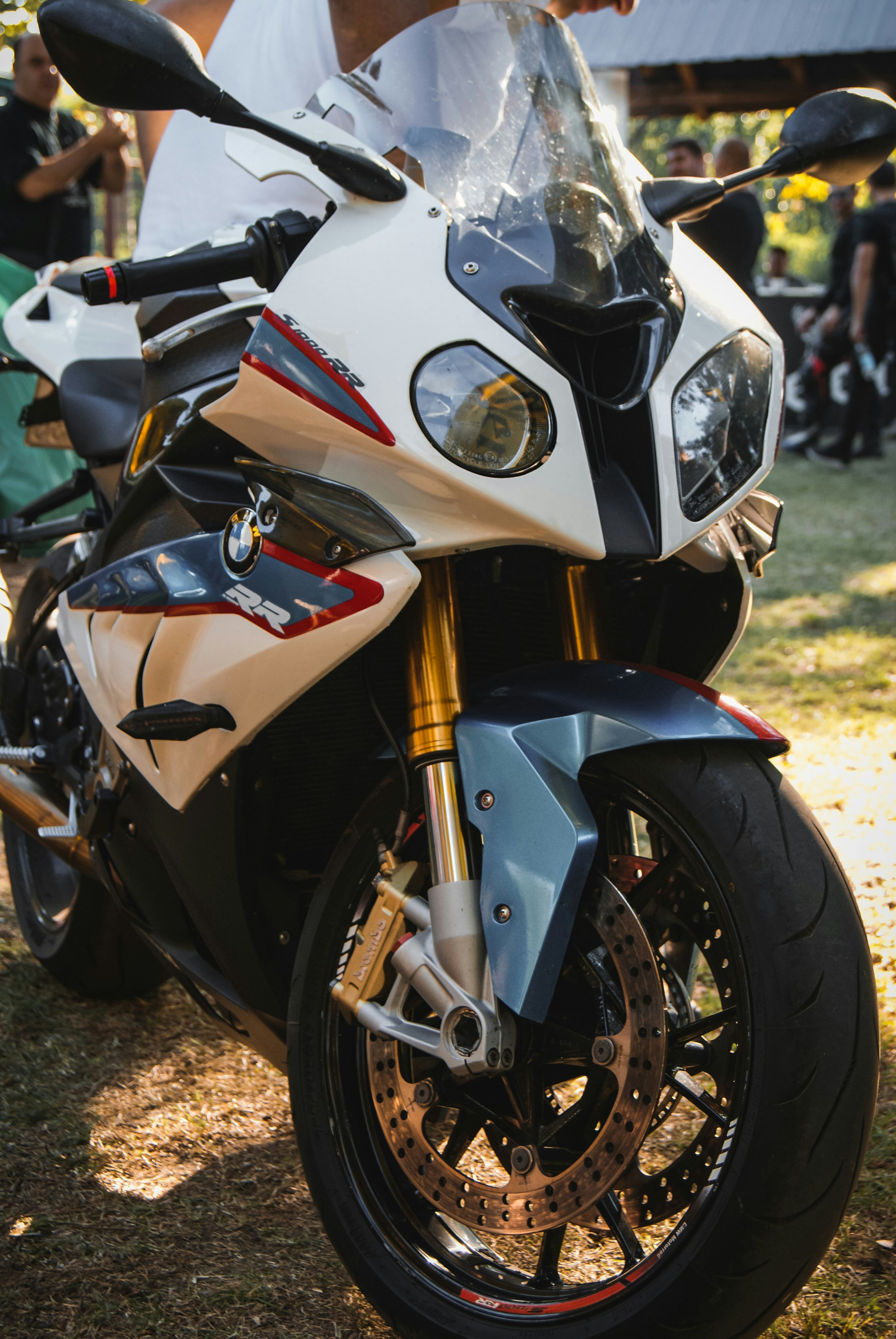 Here's a short caption: a sleek, white and blue motorcycle. photo ...