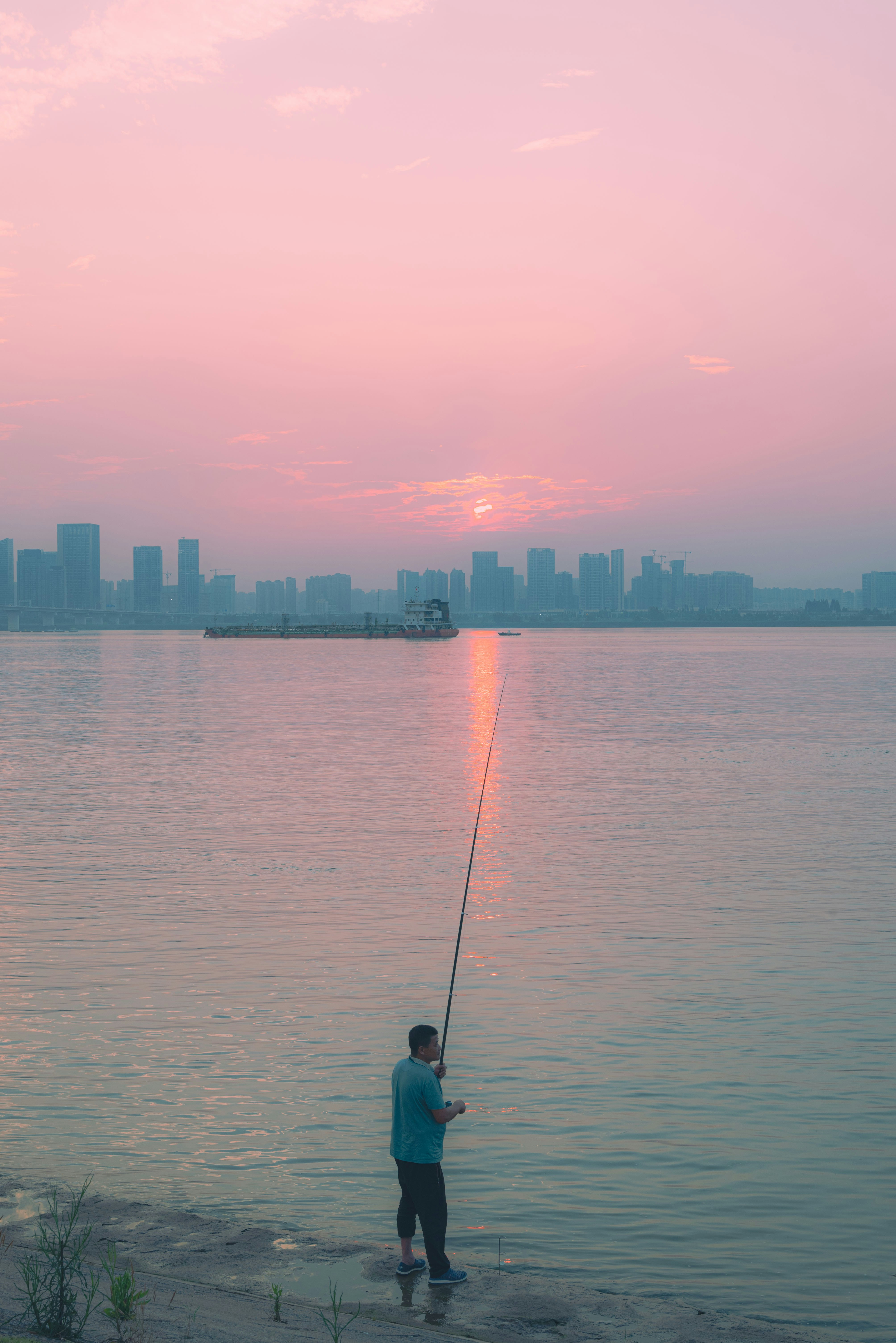 Sunset line: a lone angler at the water’s edge