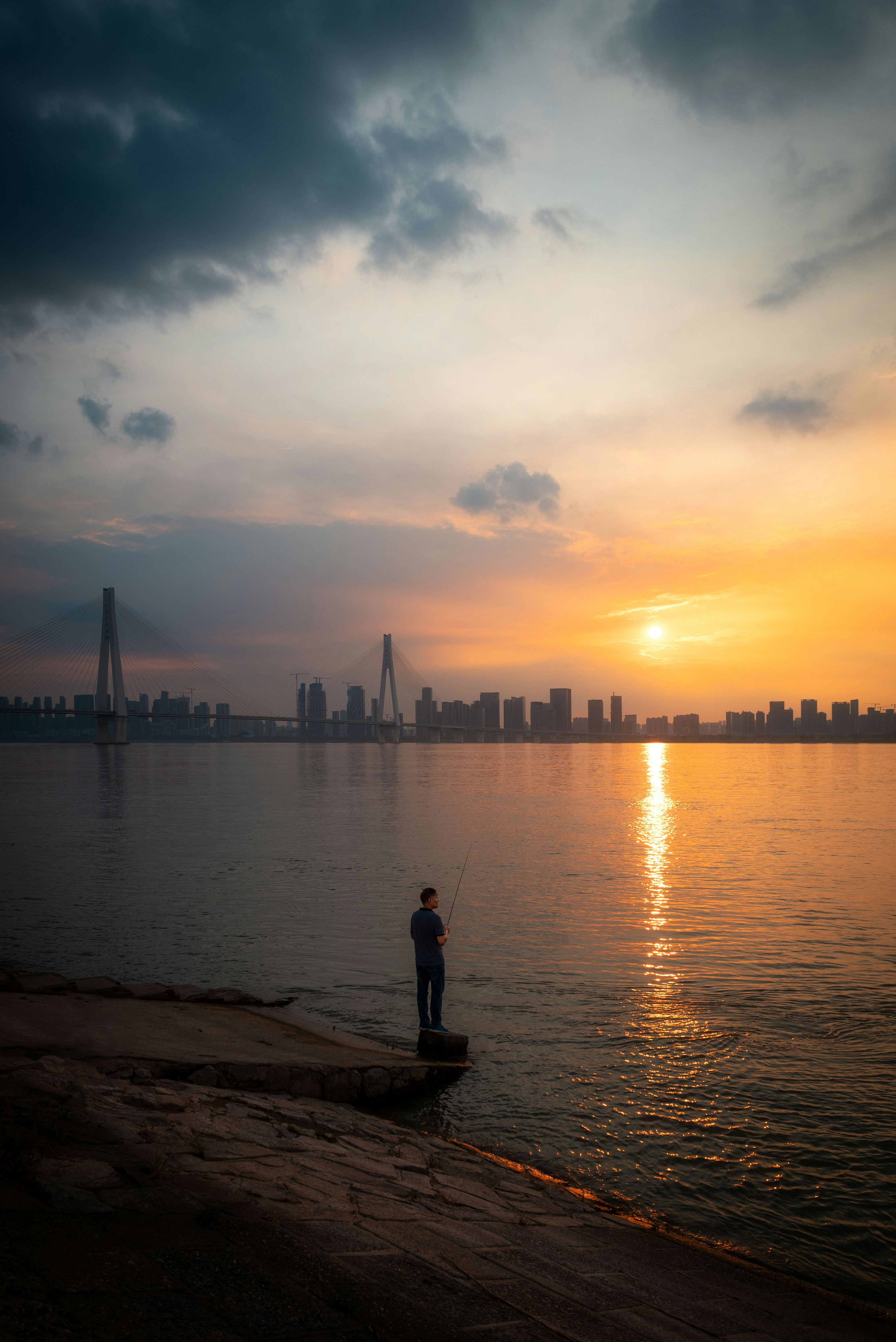 Serenity at Dusk: A Fisherman's Reflection