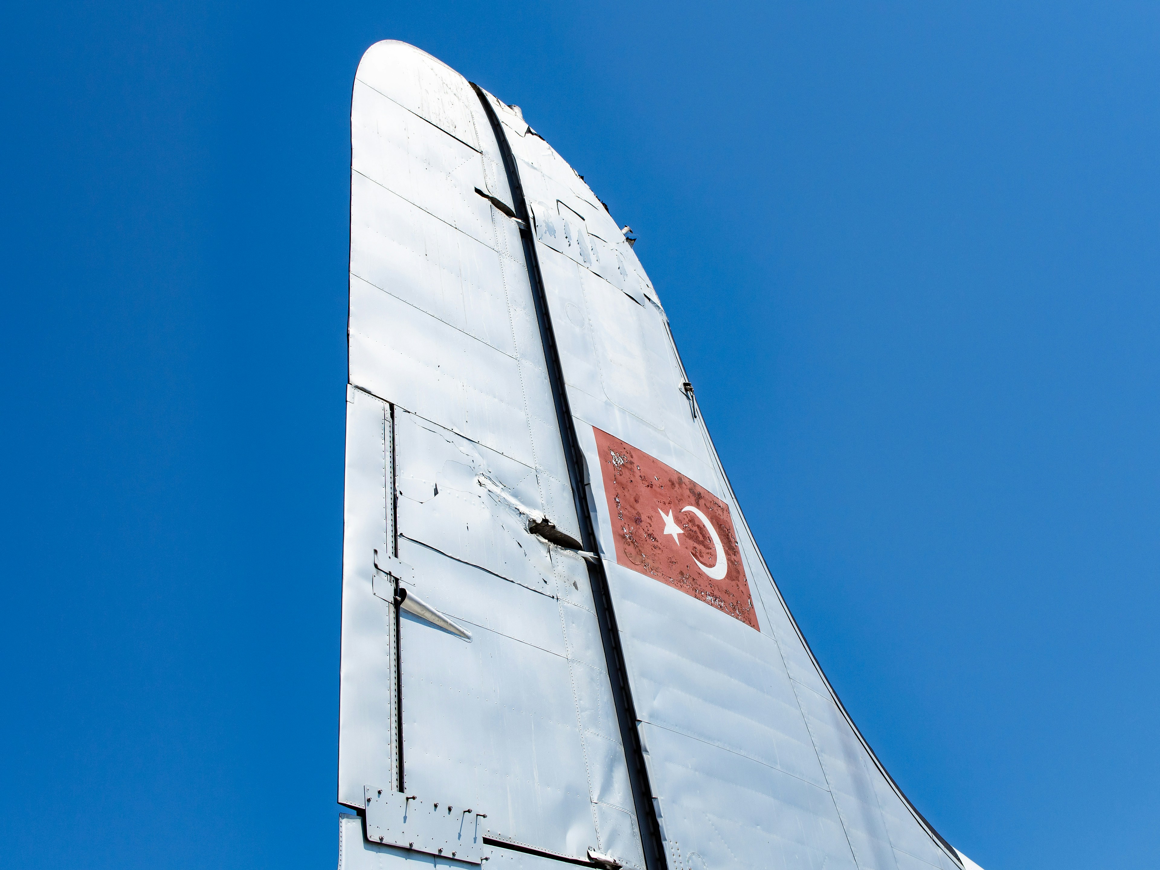 Azure Sky, Weathered Tail Fin: Turkish Emblem in Focus