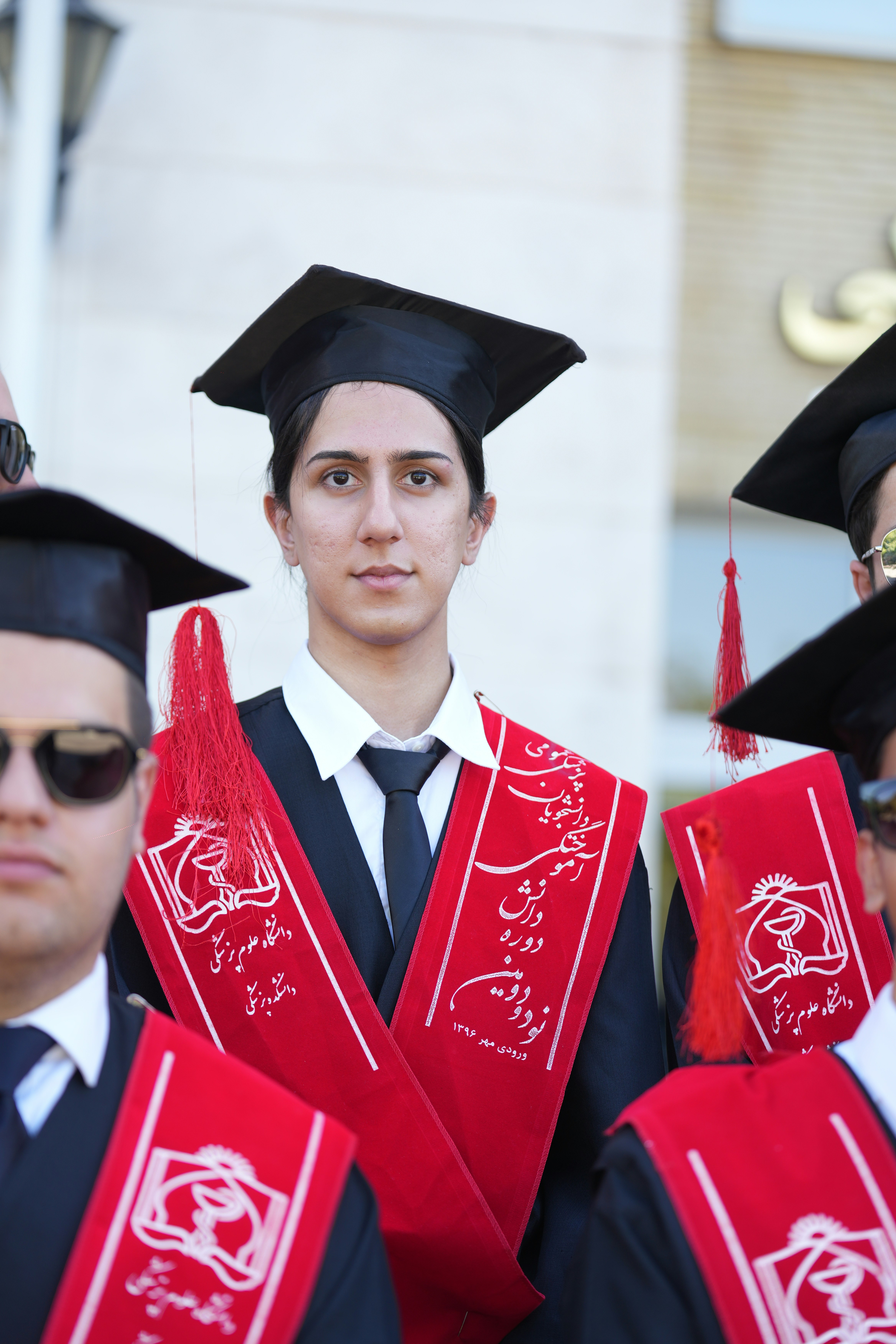 A graduate poses proudly in their graduation attire. photo – Free Woman ...