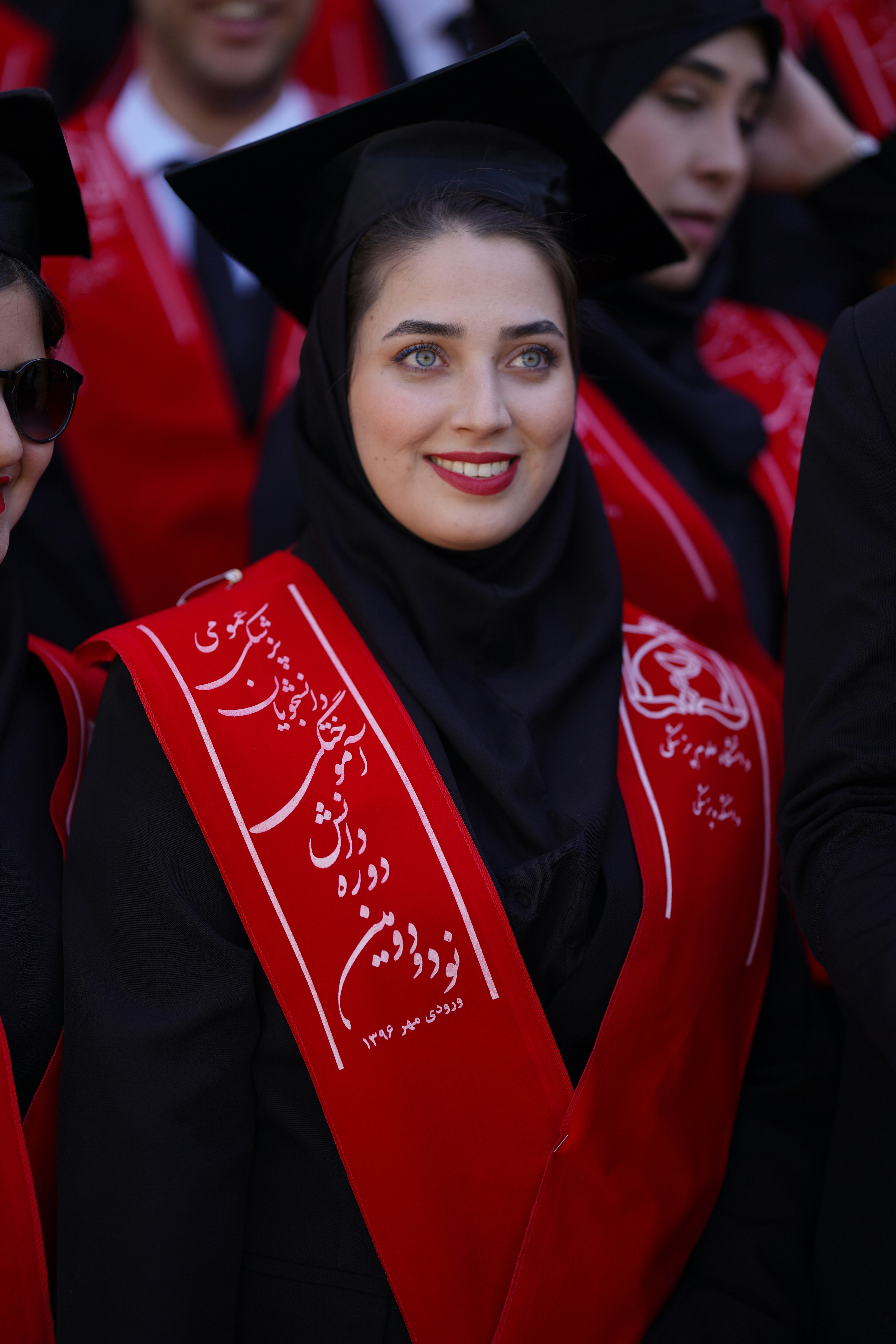 Crimson Sash Moment: A Graduate's Quiet Confidence