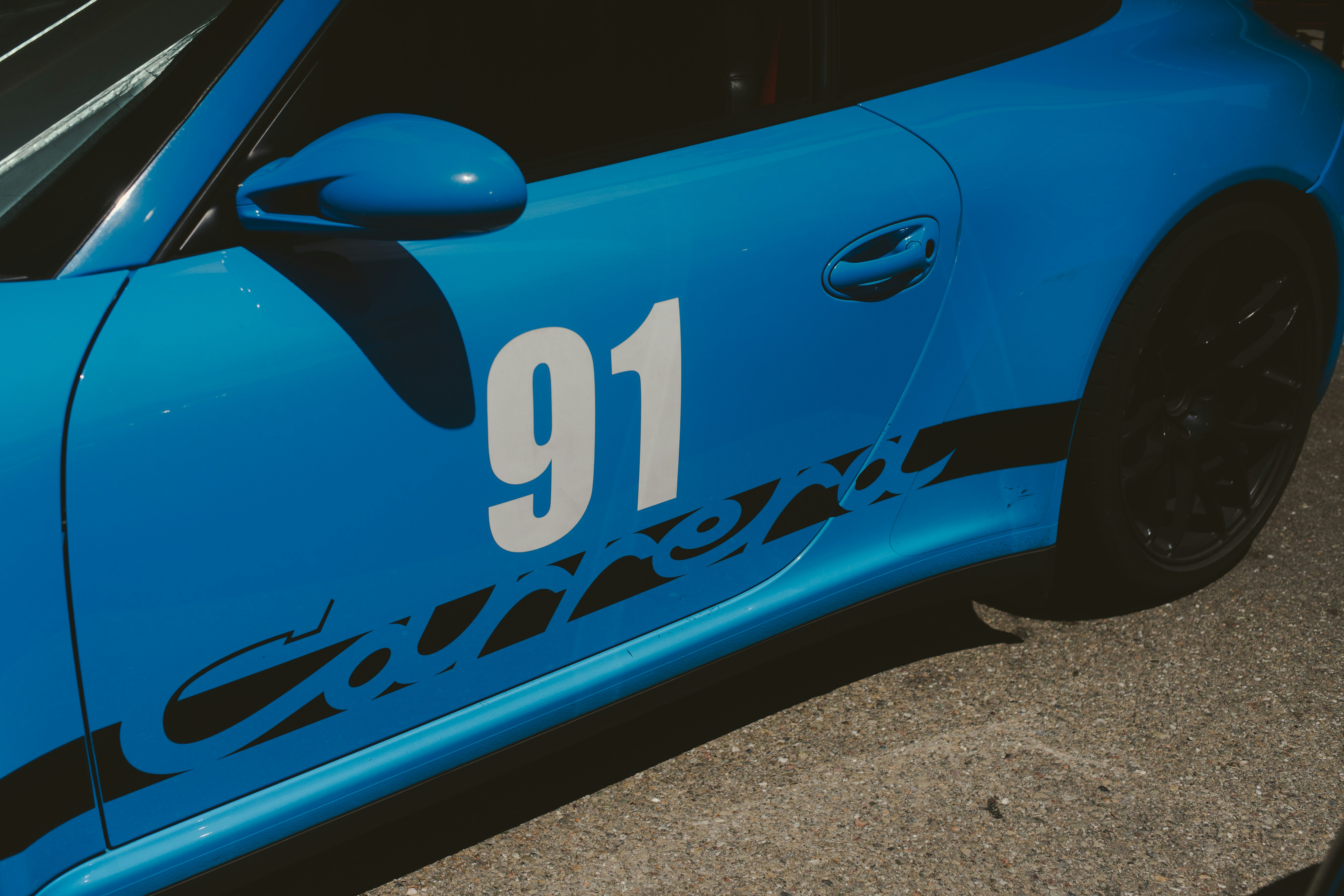 A blue sports car with the number 91. photo – Free Porsche Image on ...