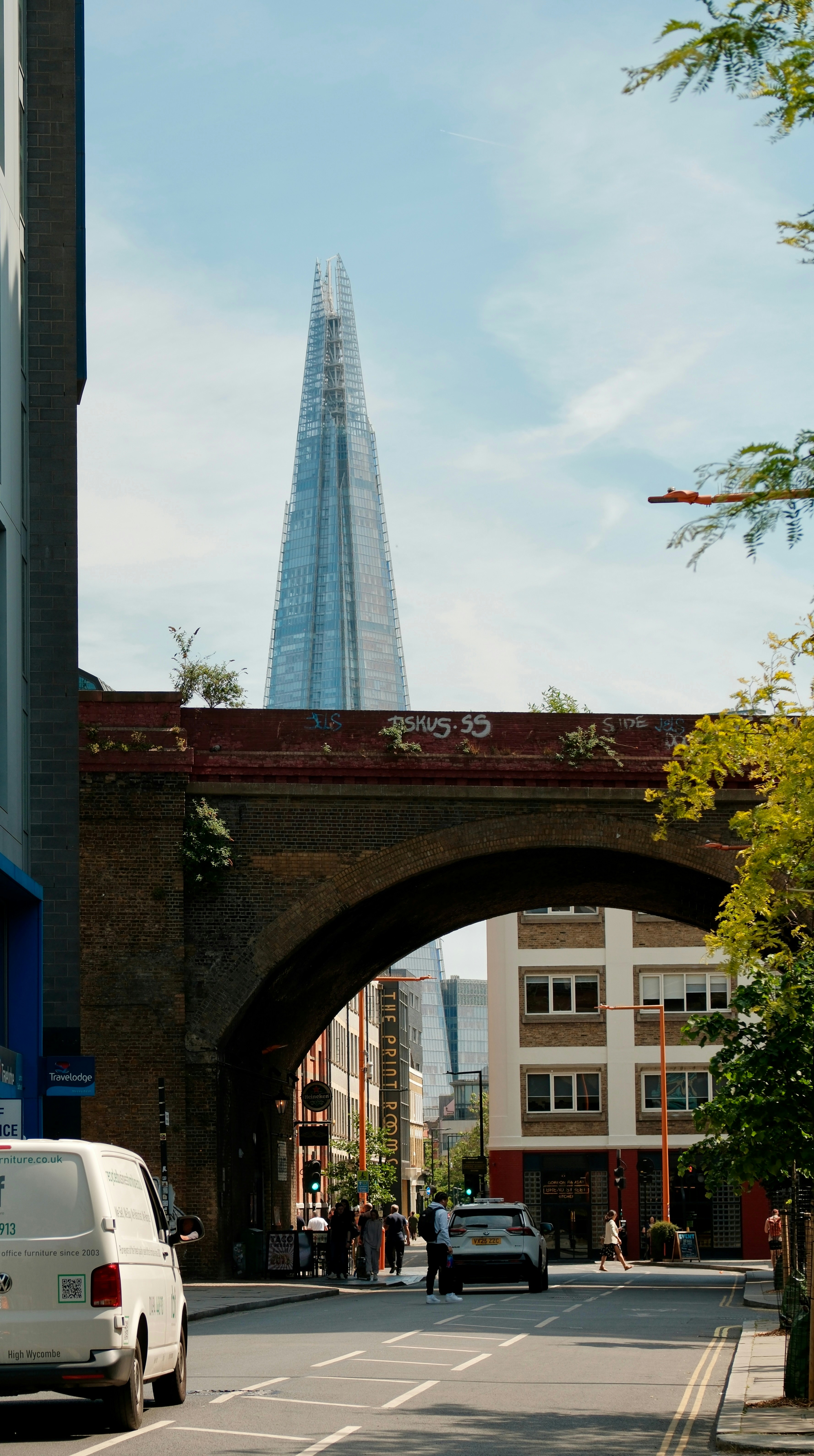 The Shard Framing a London Street Beneath the Brick Arch