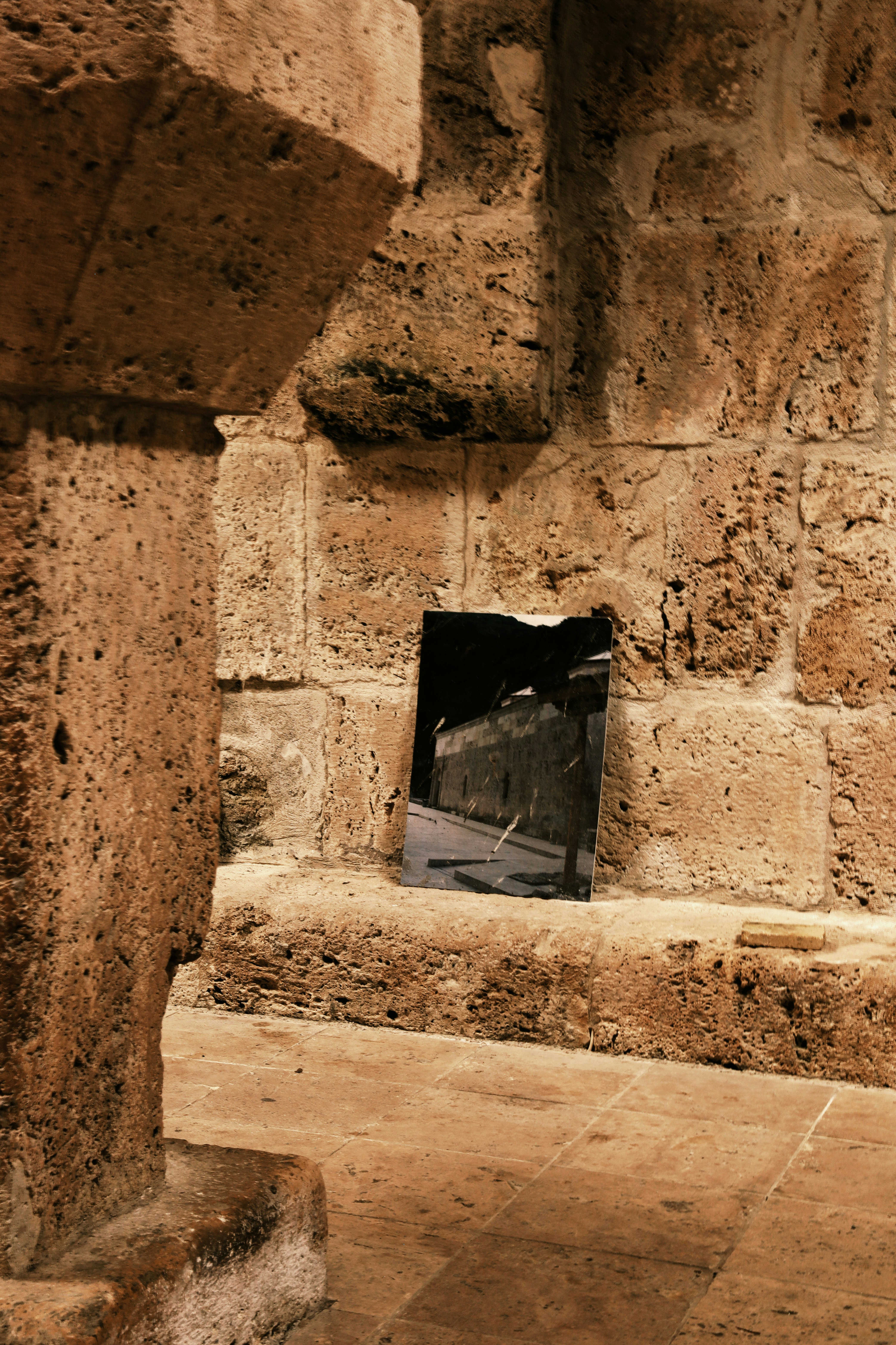 A mirror reflects light in a stone chamber. photo – Free Painting Image ...