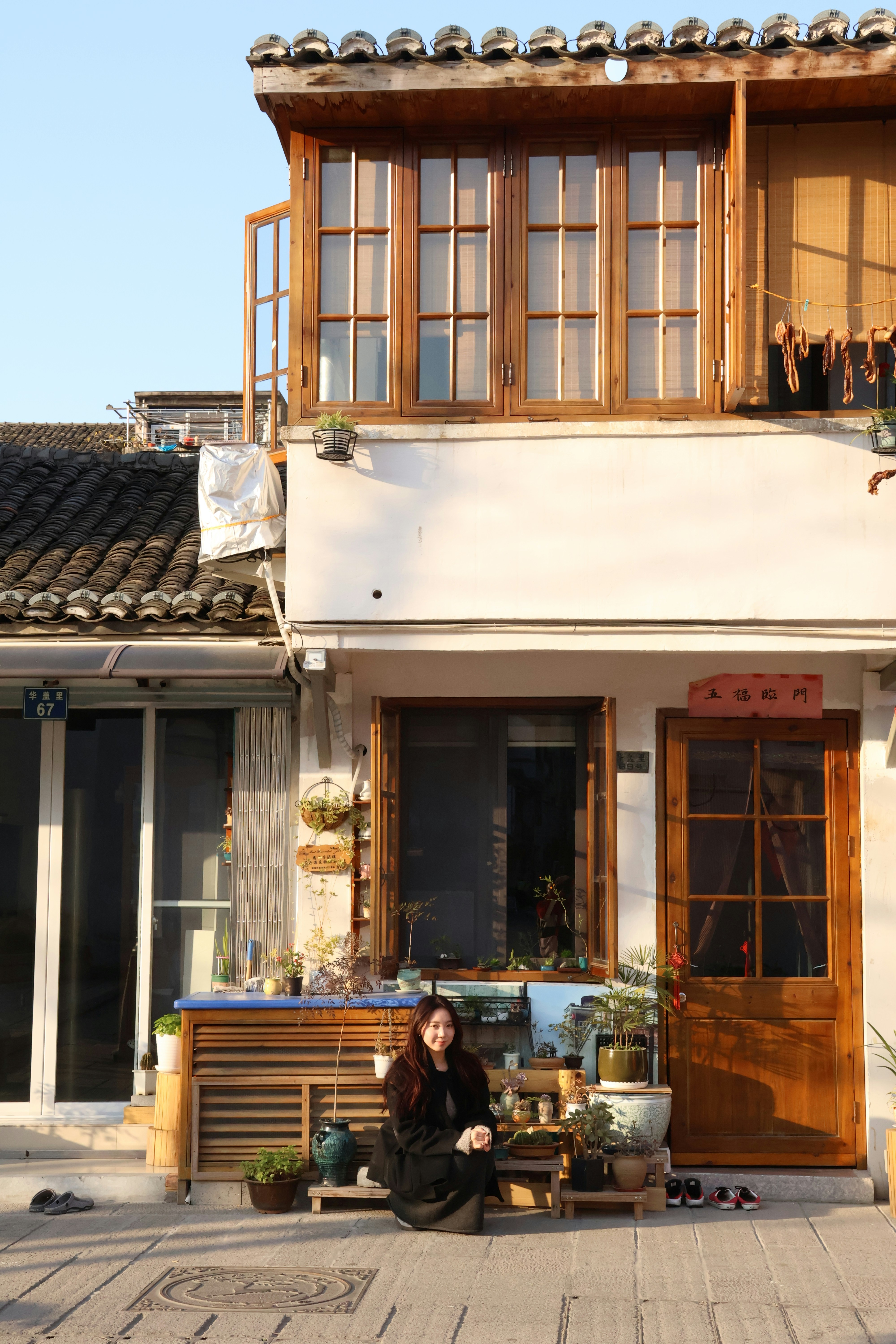 Sunlit Courtyard Portrait Beneath a Wooden Facade