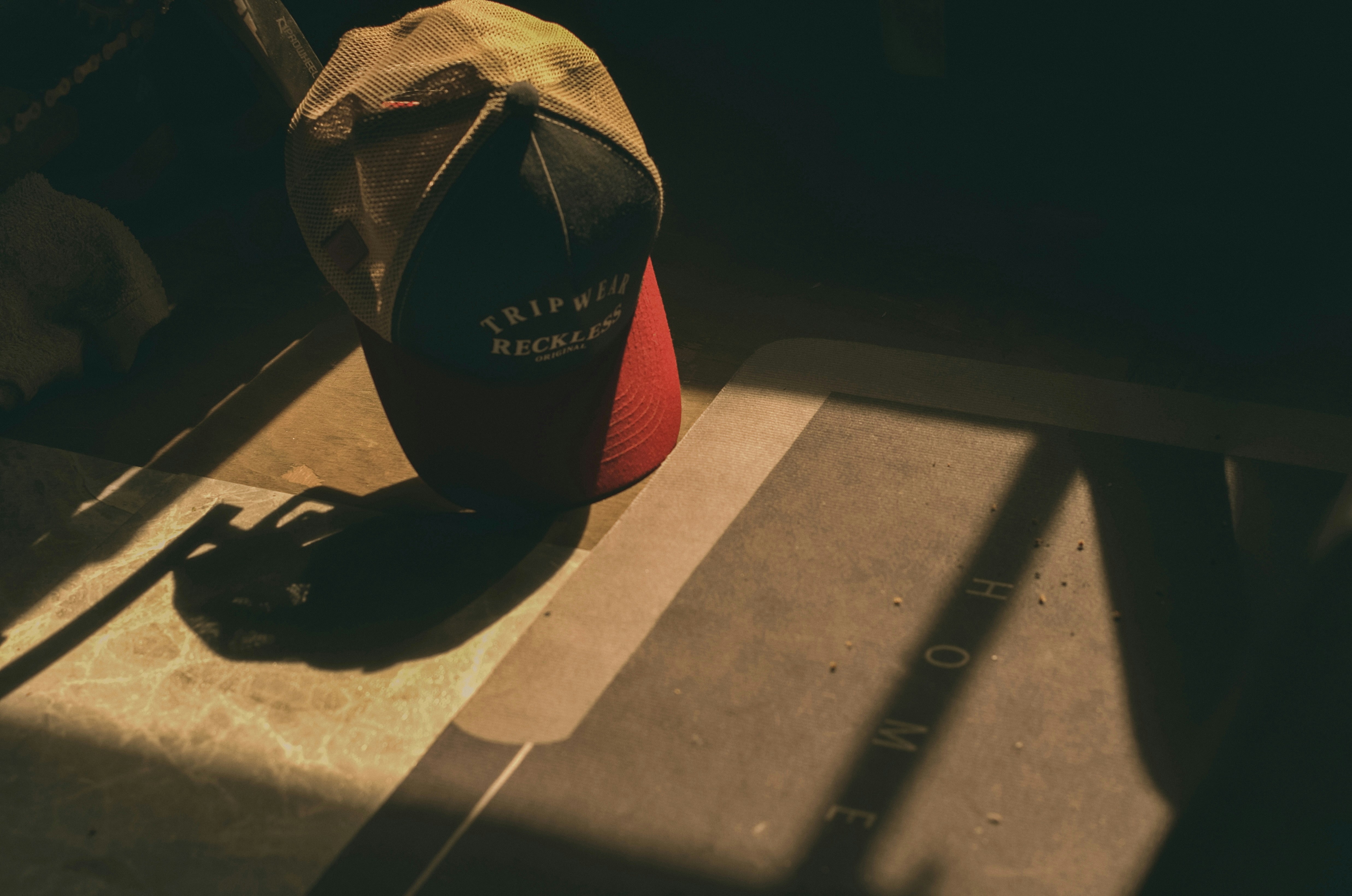A hat casts a shadow on a "home" mat. photo – Free Philippines Image on ...