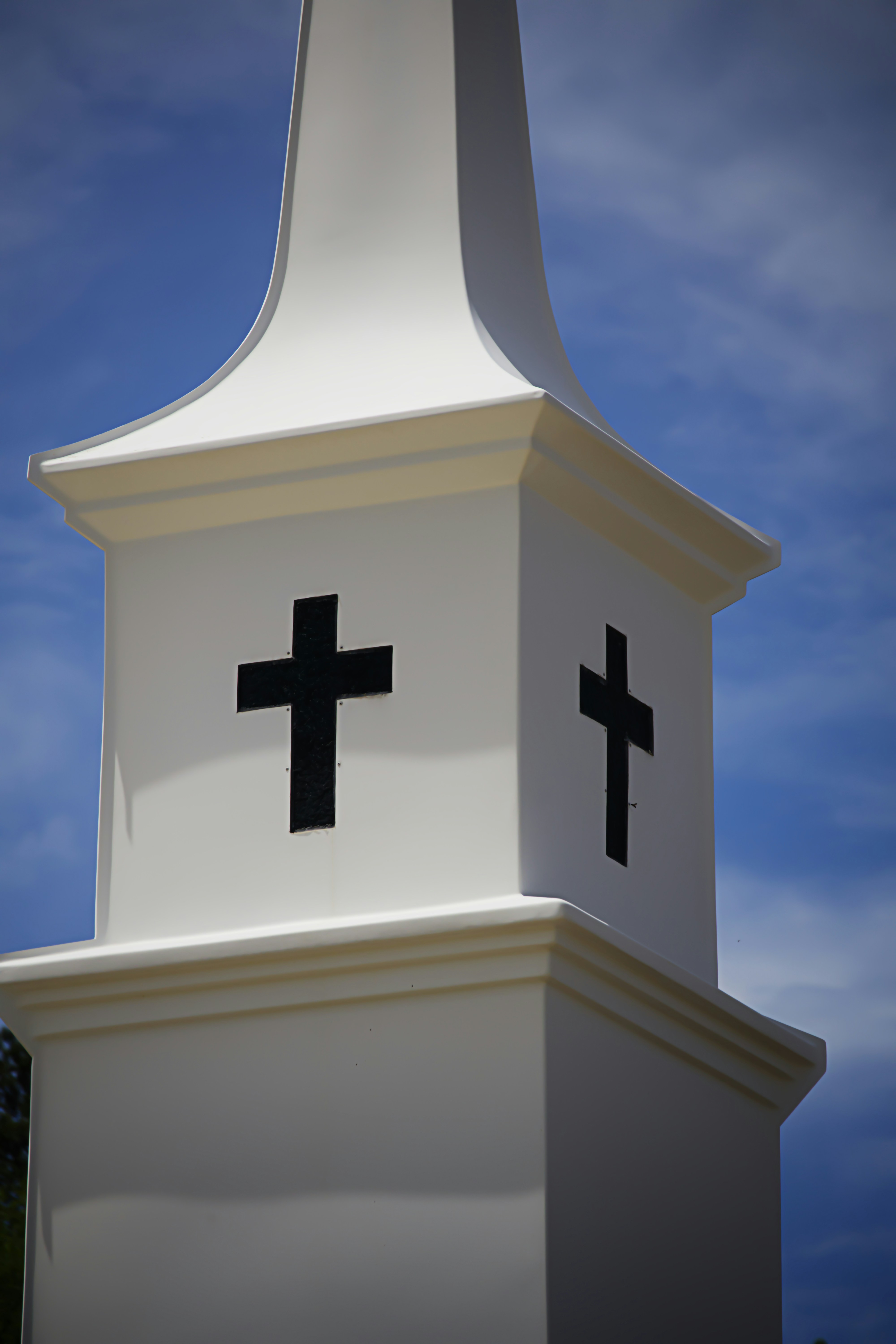 A white church steeple with black crosses. photo – Free Church Image on ...