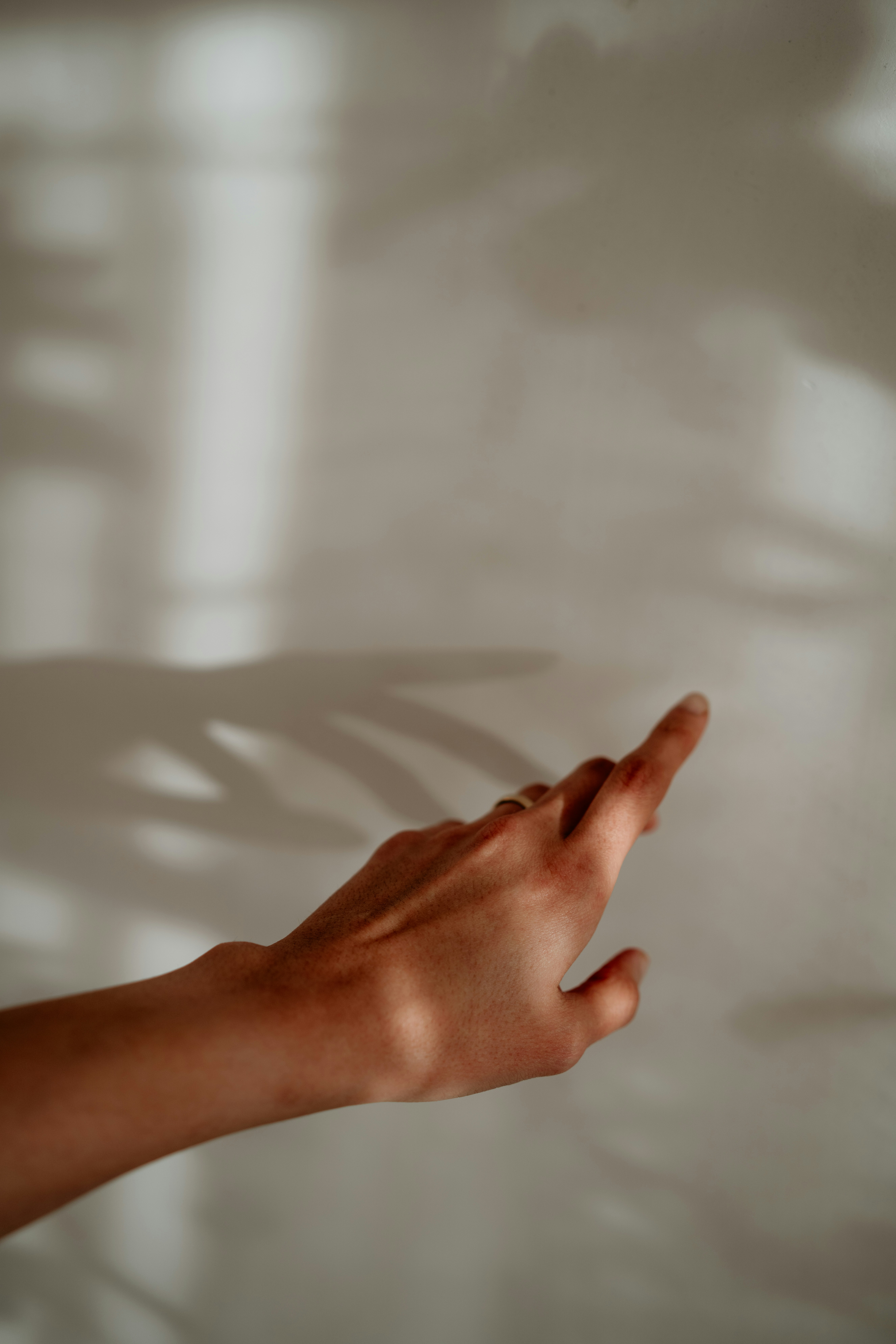 A hand reaches out with shadows on the wall. photo – Free Hand Image on ...