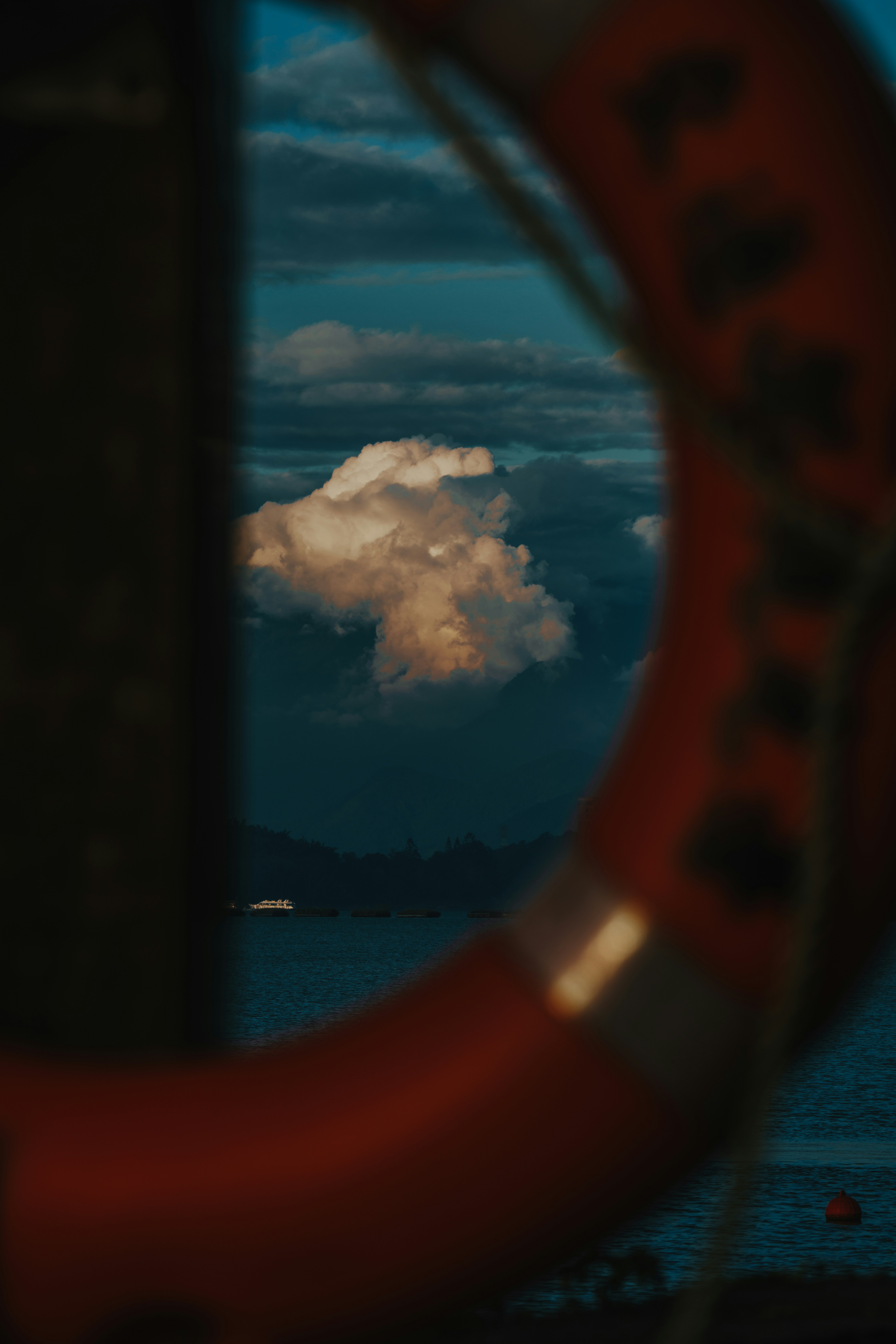 A cloud is viewed through a life ring.