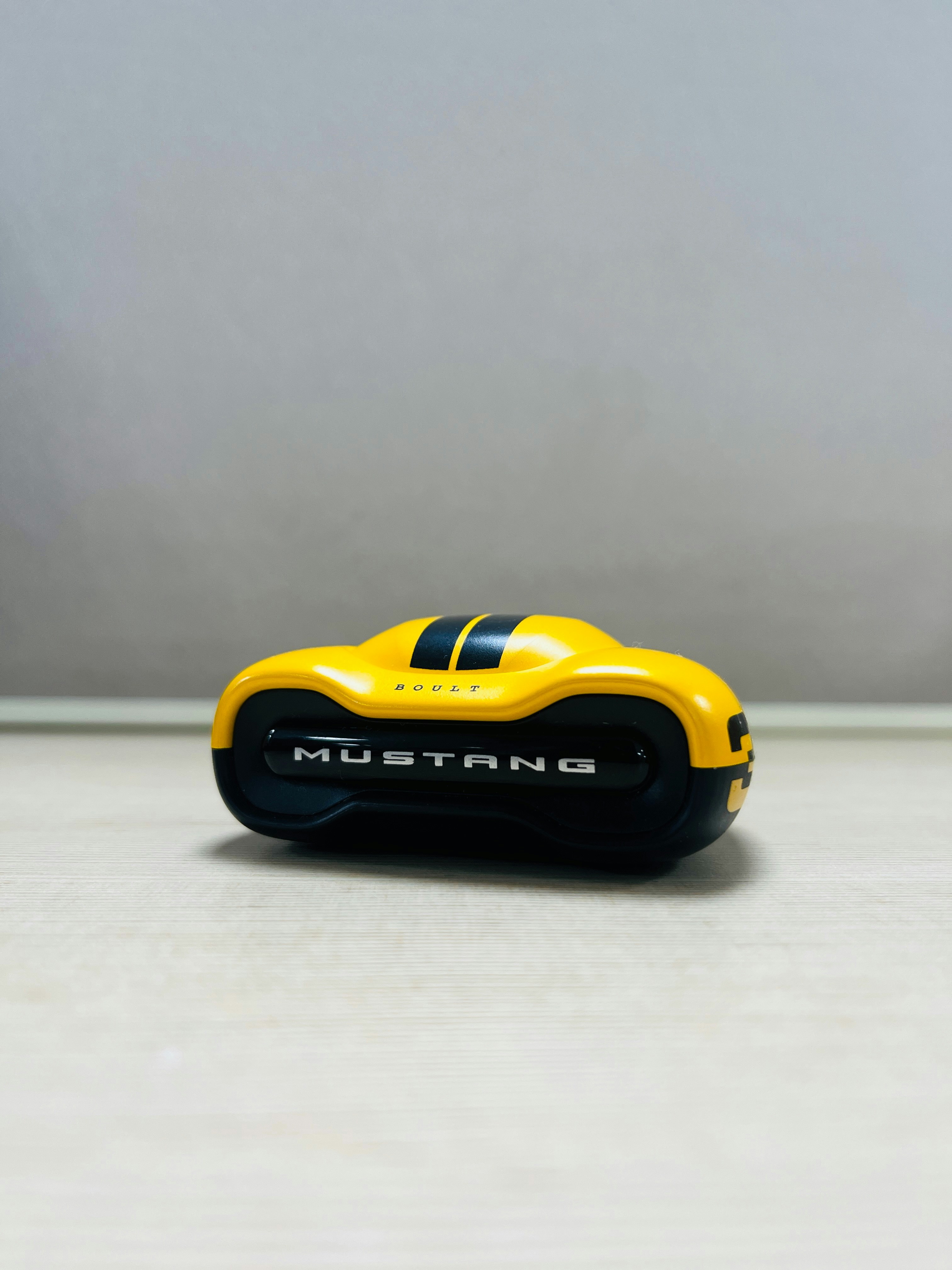 Desk-Top Mustang: A Yellow Die-Cast Racer on Quiet Wood
