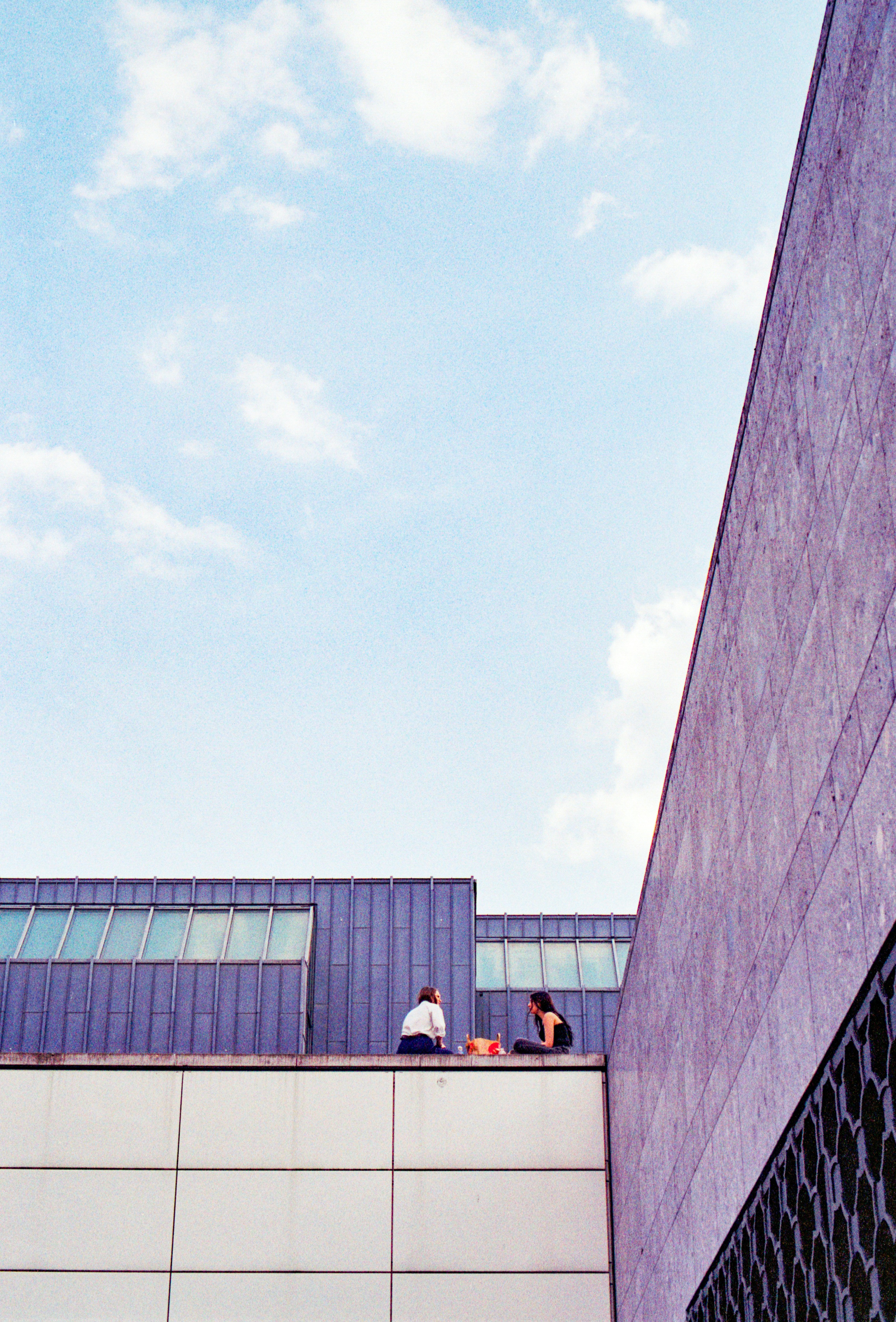 Two people relax on a building's rooftop. photo – Free Film photography ...