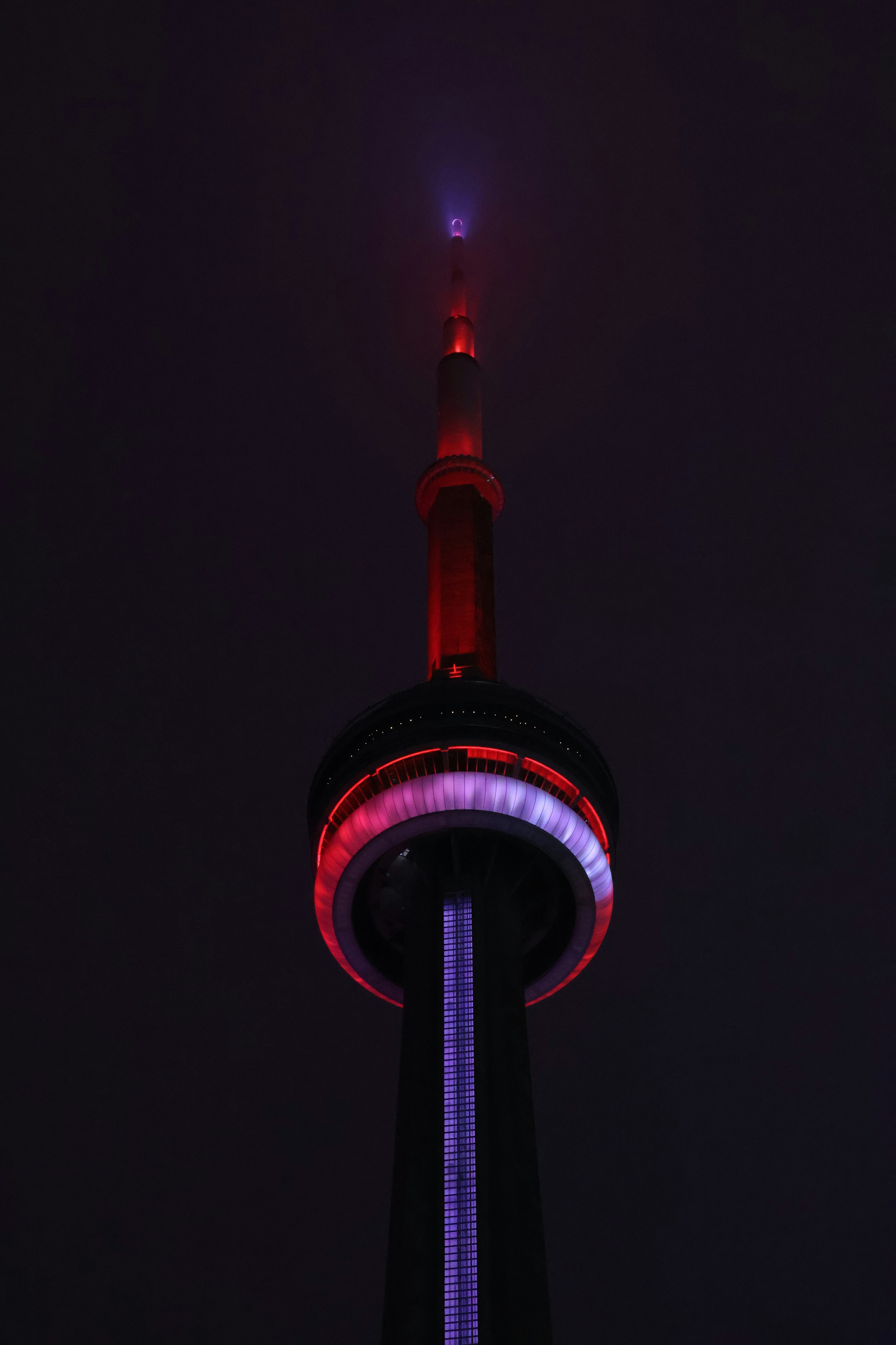 Closeup view of the CN tower in Toronto, Canada from below at night