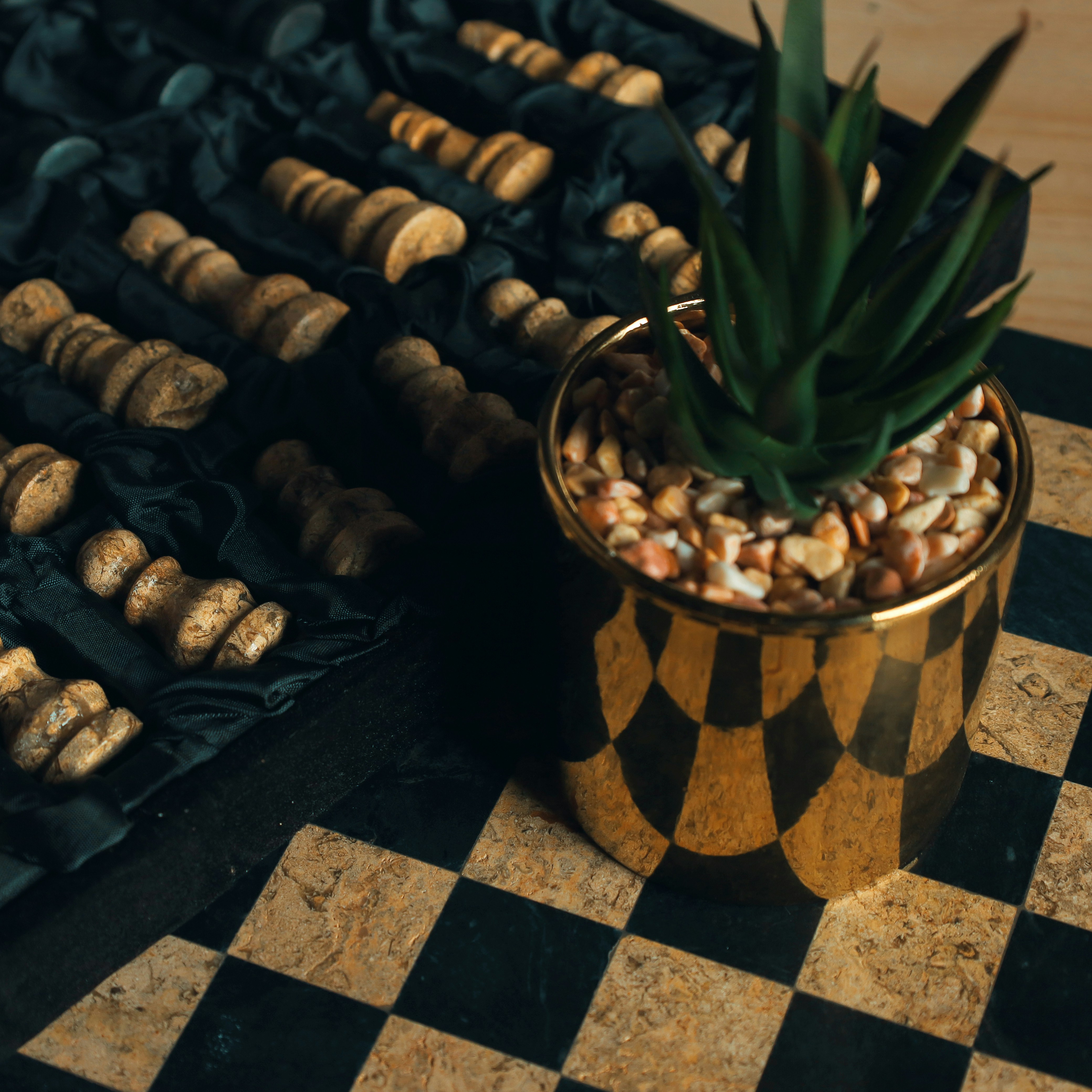 Gilded Pot, Jade Sprout: Quiet Geometry on a Checkered Stage