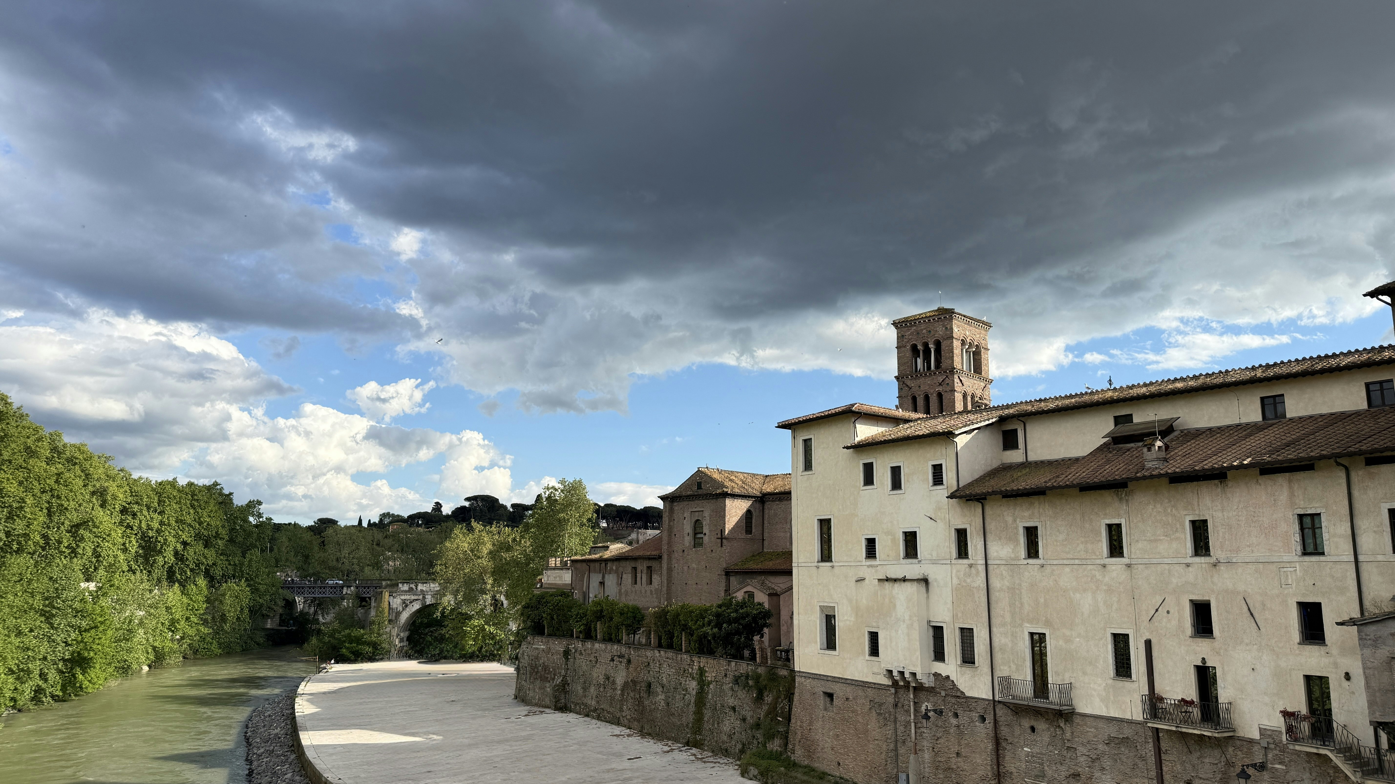 Riverside Stonework: Towered Facades Under a Brooding Sky
