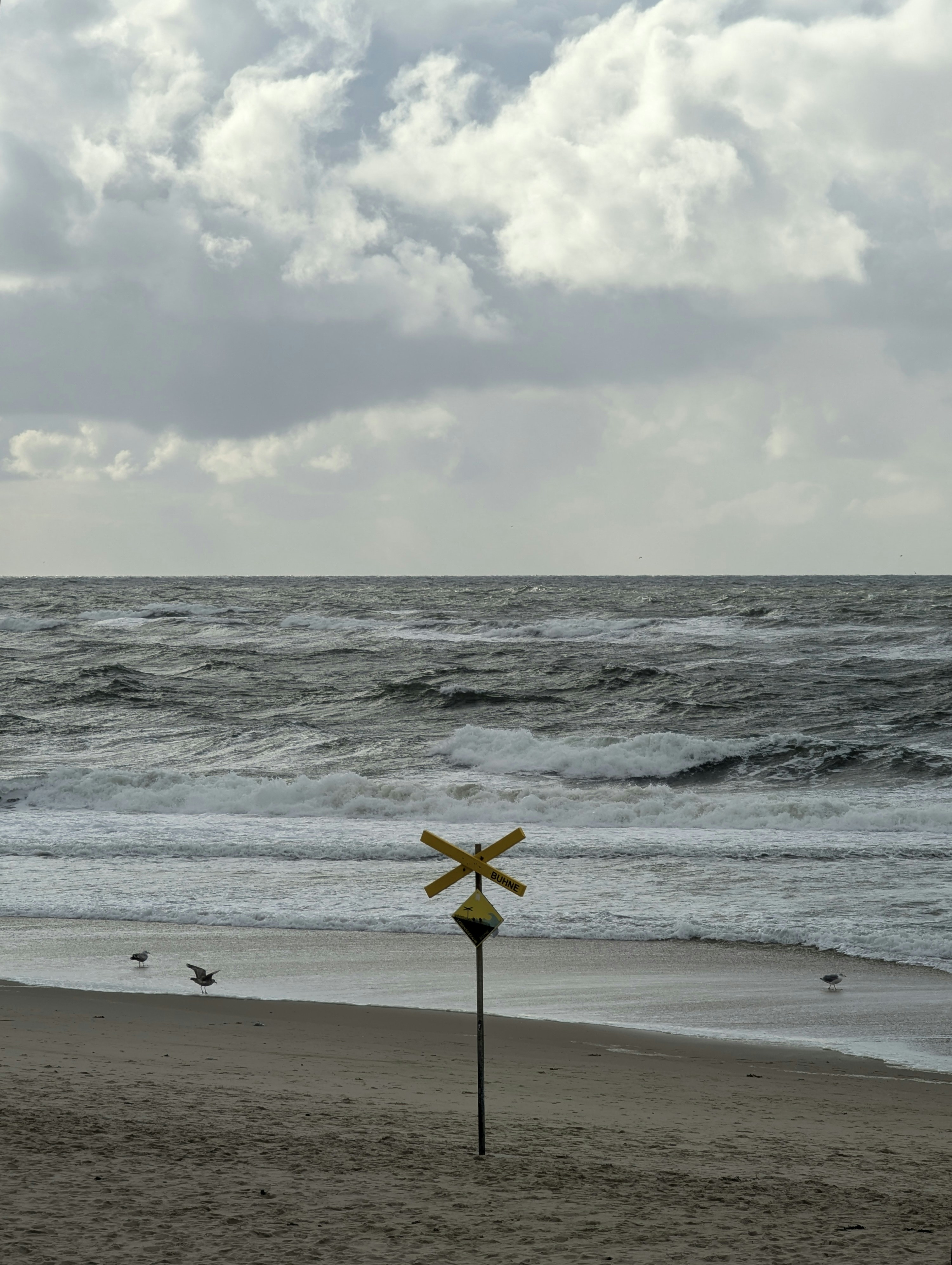 Yellow X on the Shore: A Minimalist Beach Signal