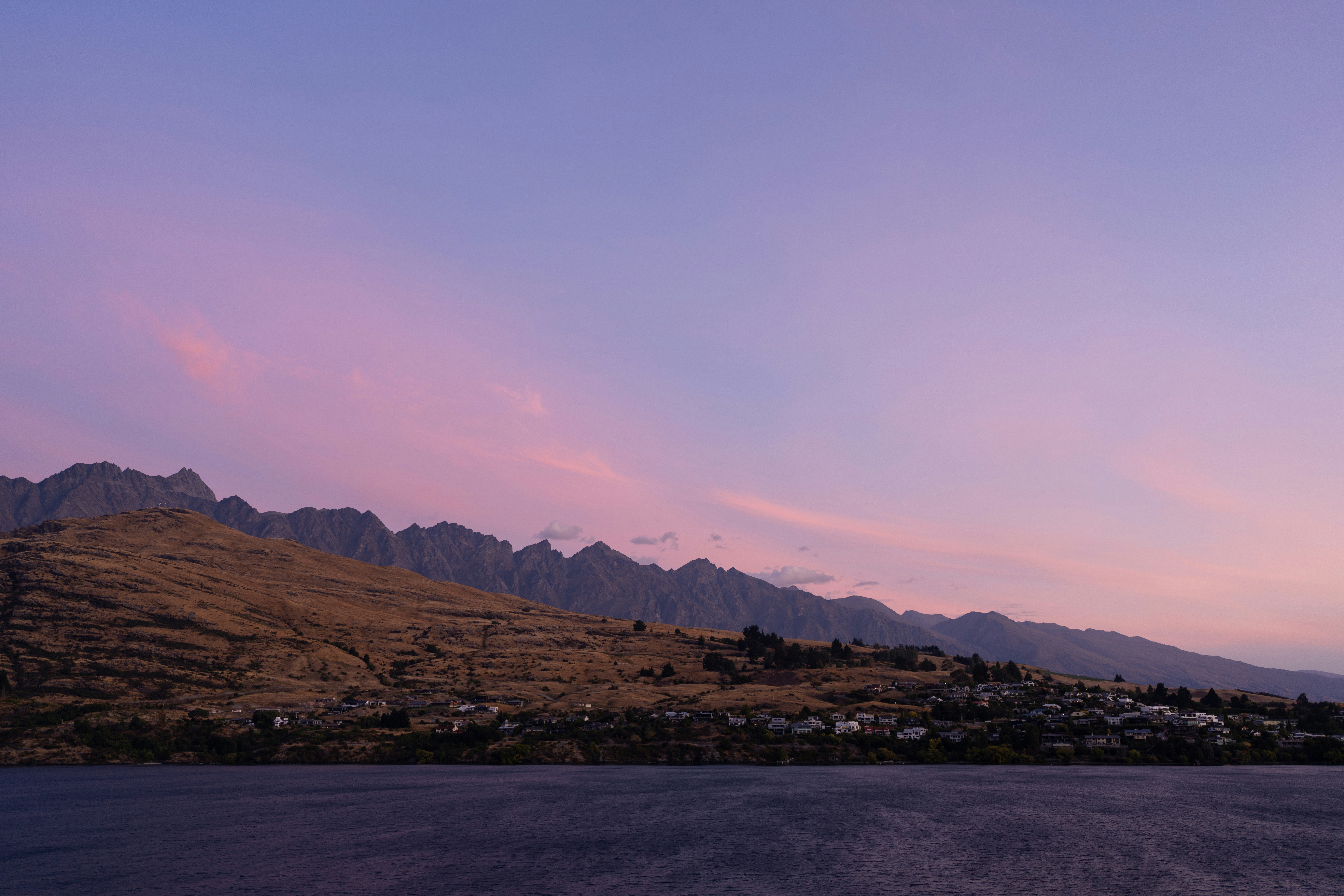 Dusk Over the Coastal Ridge: Quiet Harbor Beneath Painted Skies
