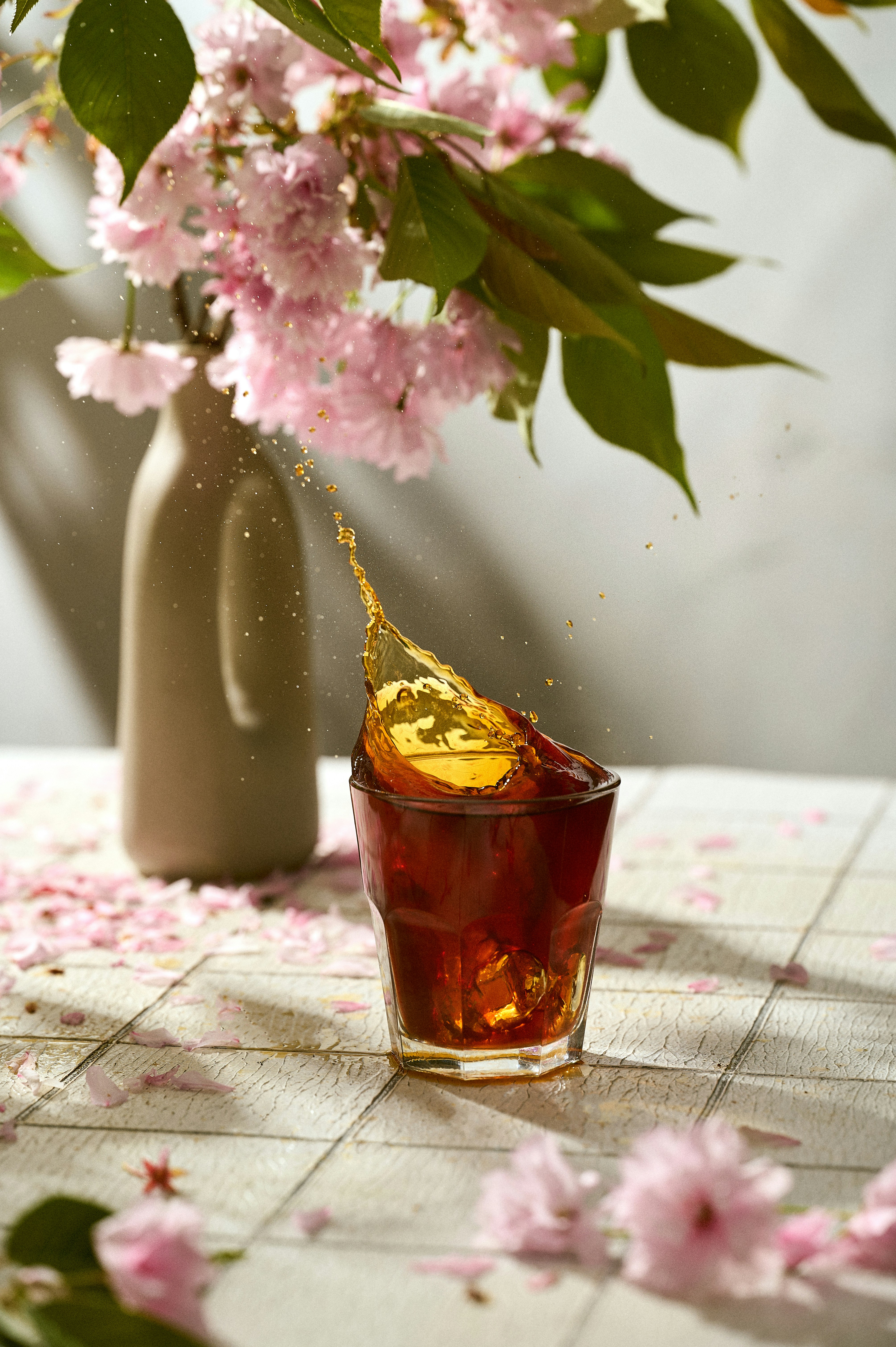 Citrus Splash: A Glass of Deep Red with Pink Petals