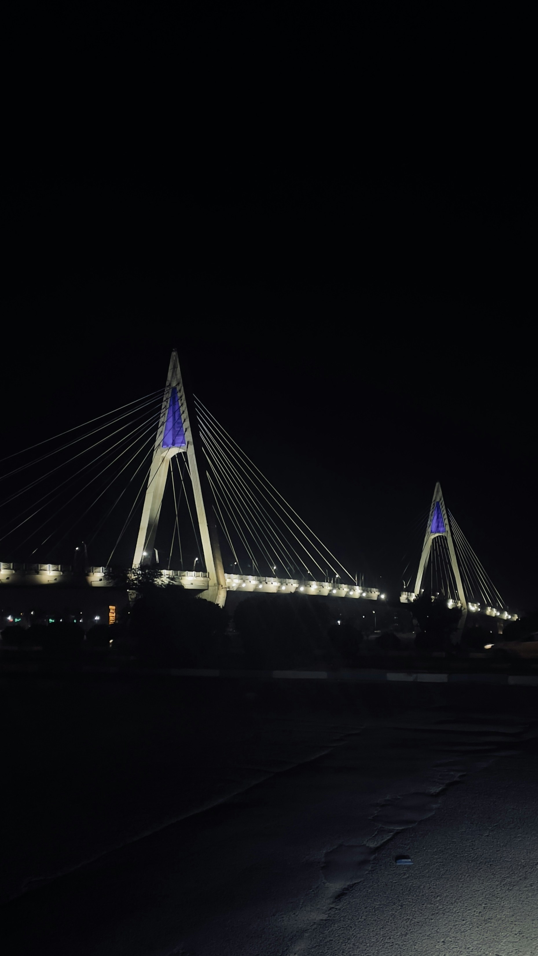 A lit-up bridge stands out in the dark night. photo – Free Bridge Image ...