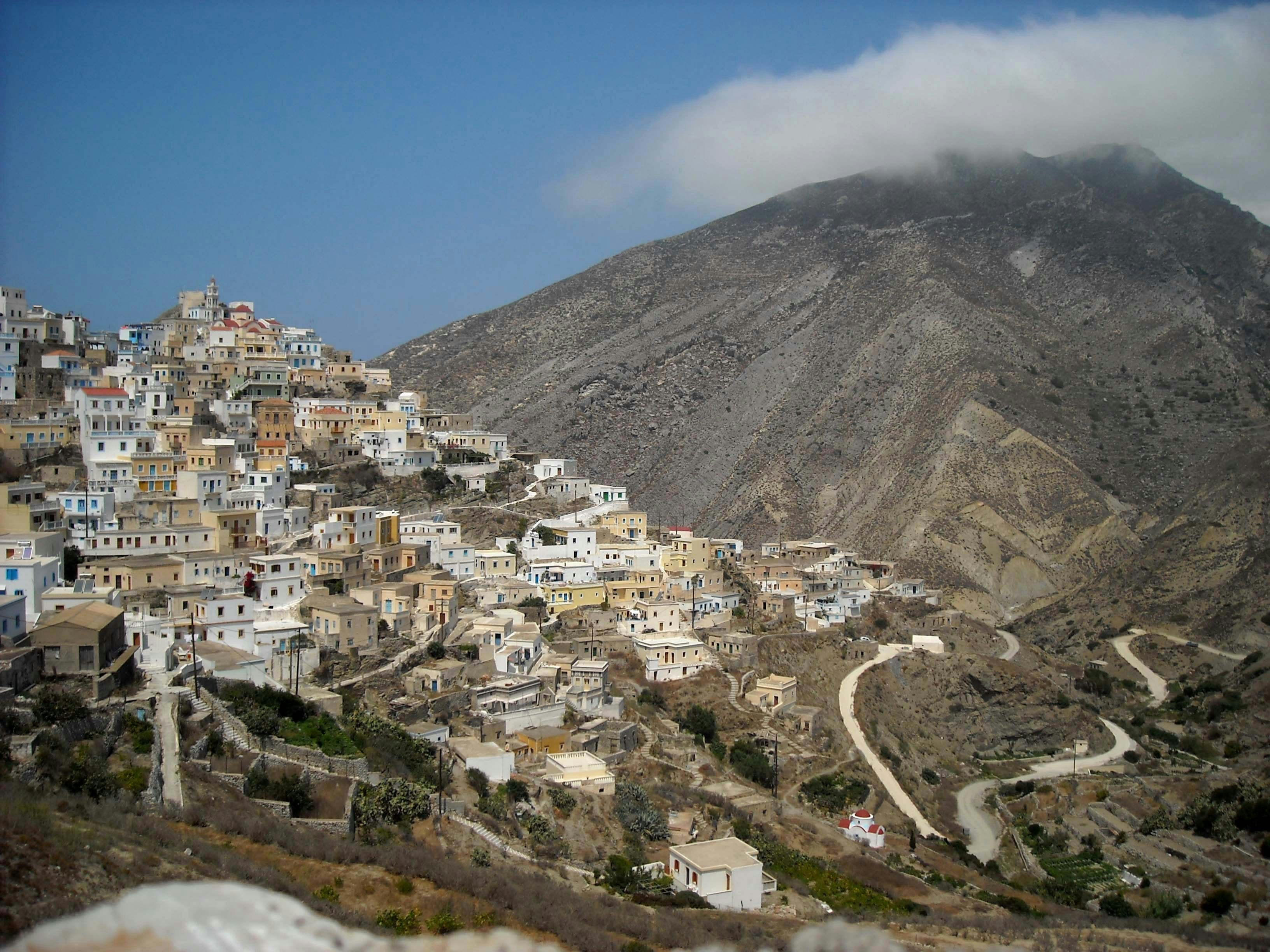 A hillside town sits beneath a cloudy mountain. photo – Free Summer ...