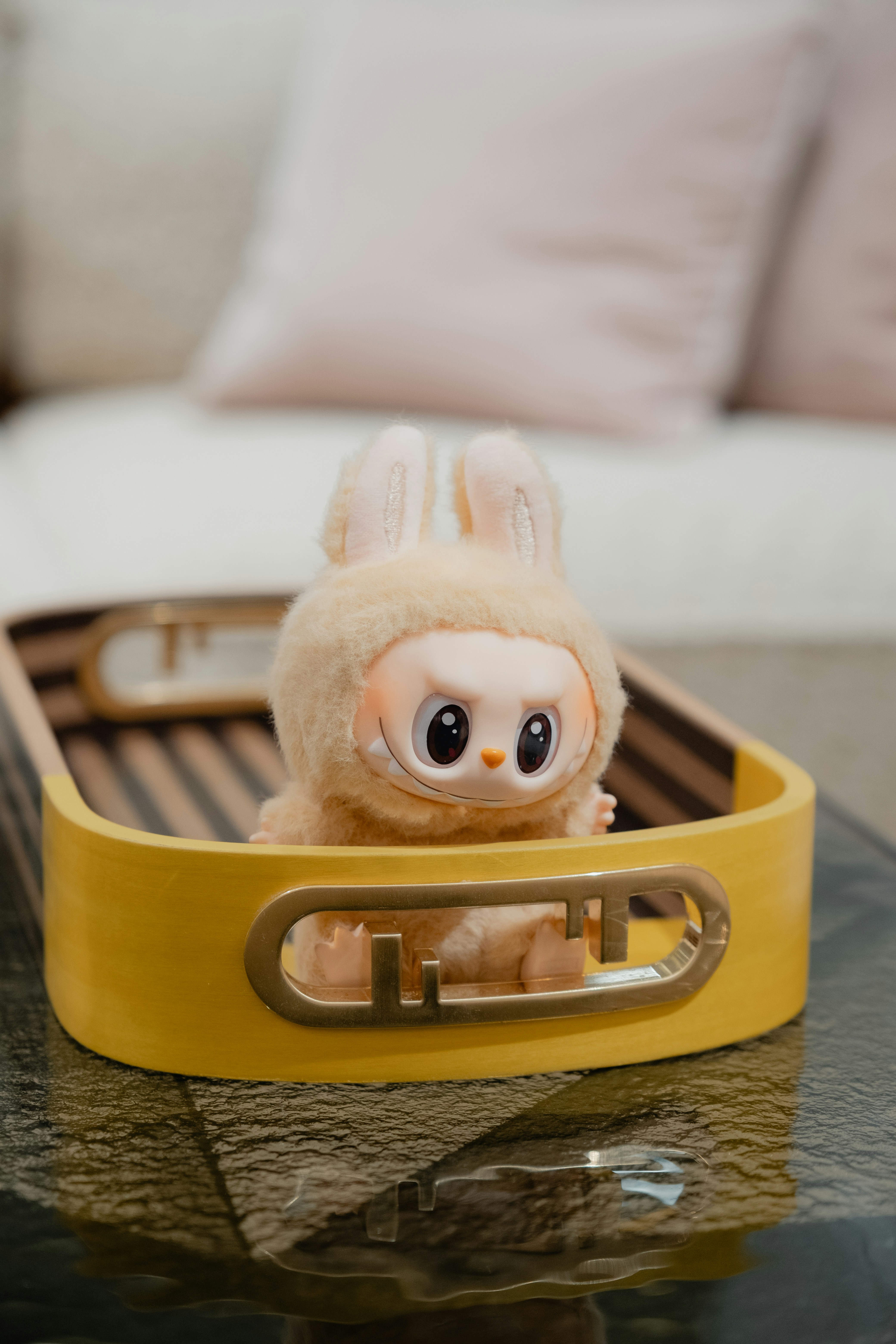 Whiskers in a Sunlit Cart: A Plush Toy's Quiet Moment on Glass