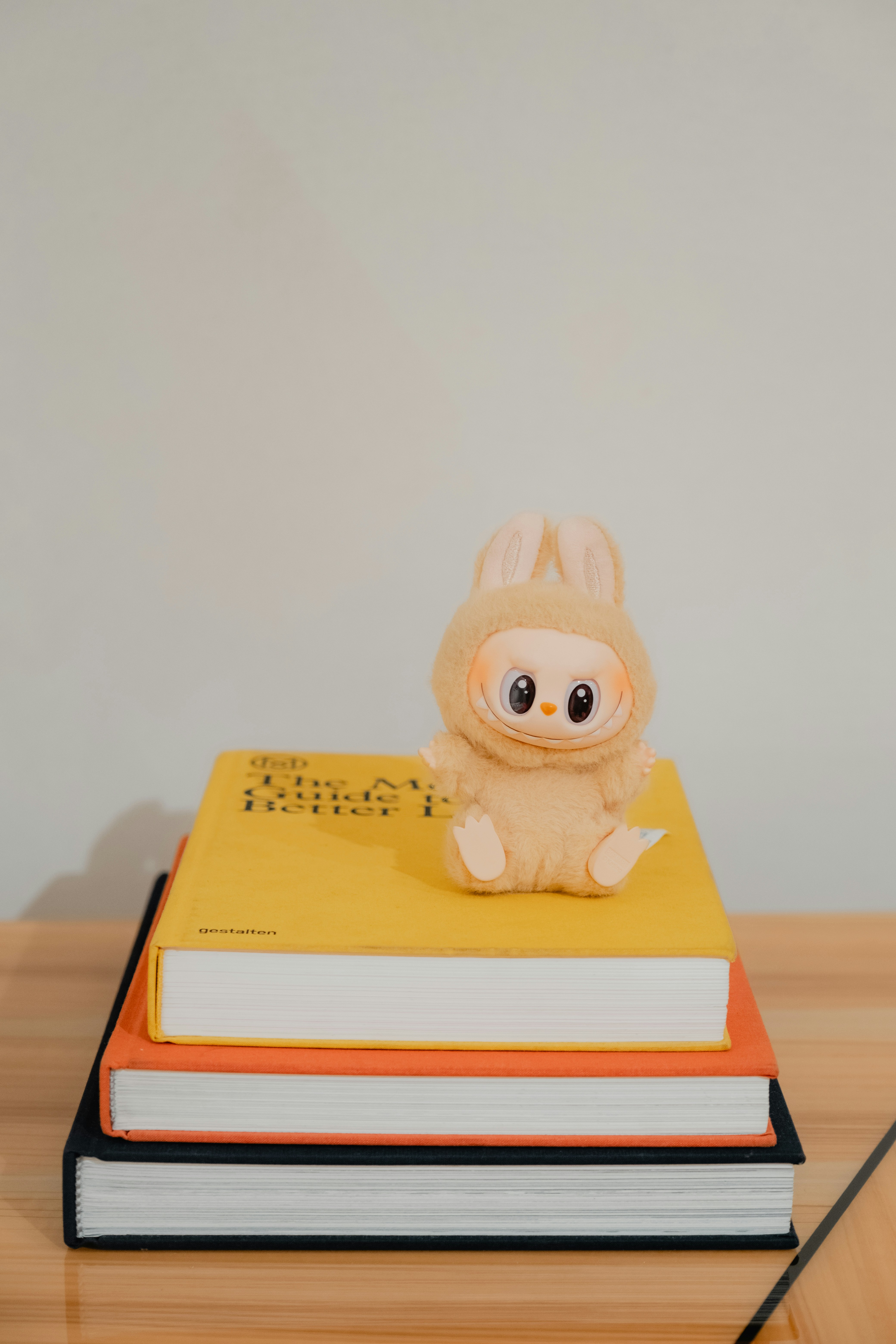 Stacked Stories: A Plush Bunny Guards a Sunny Yellow Book