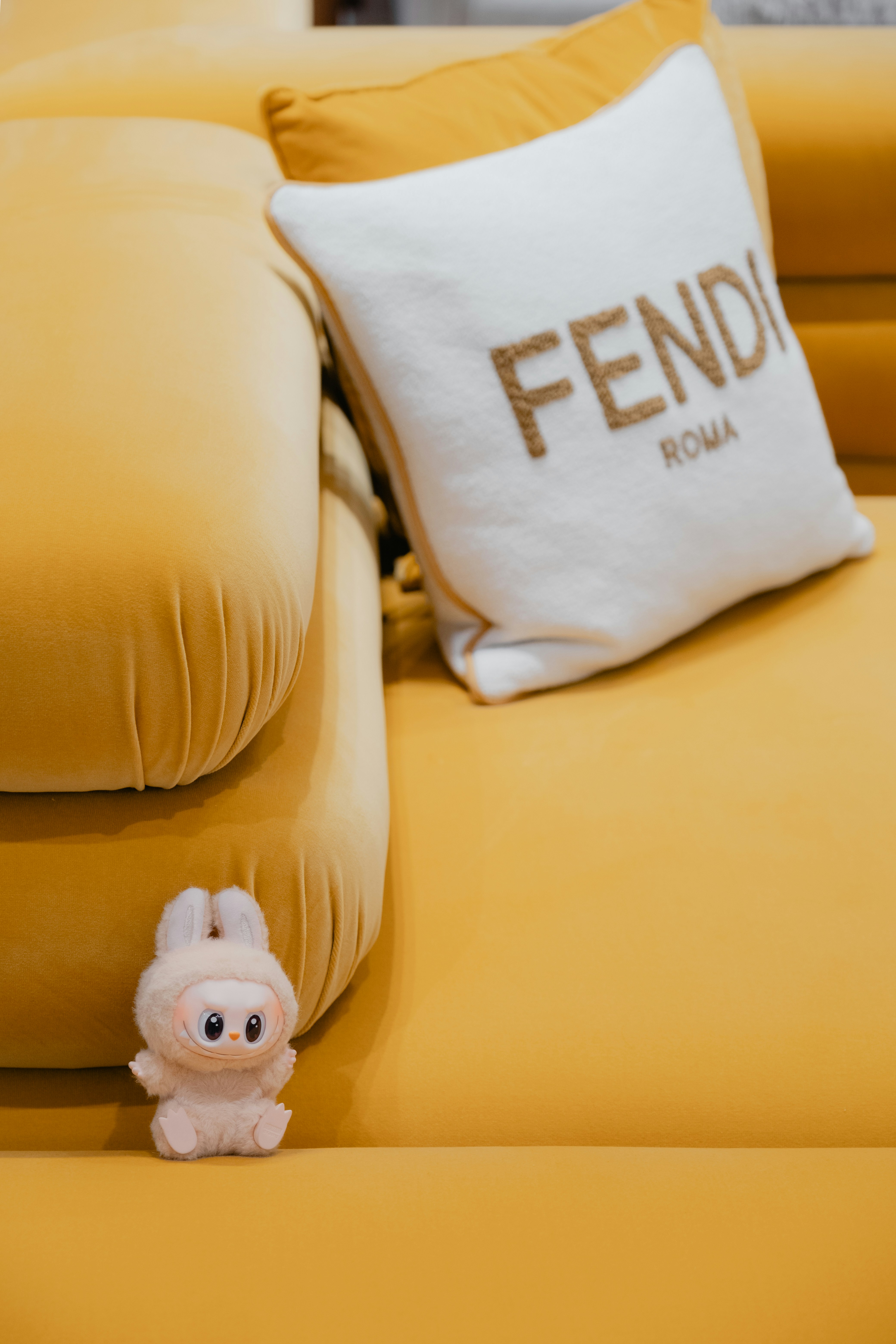 Tiny Plush Bunny on a Sunlit Fendi Sofa
