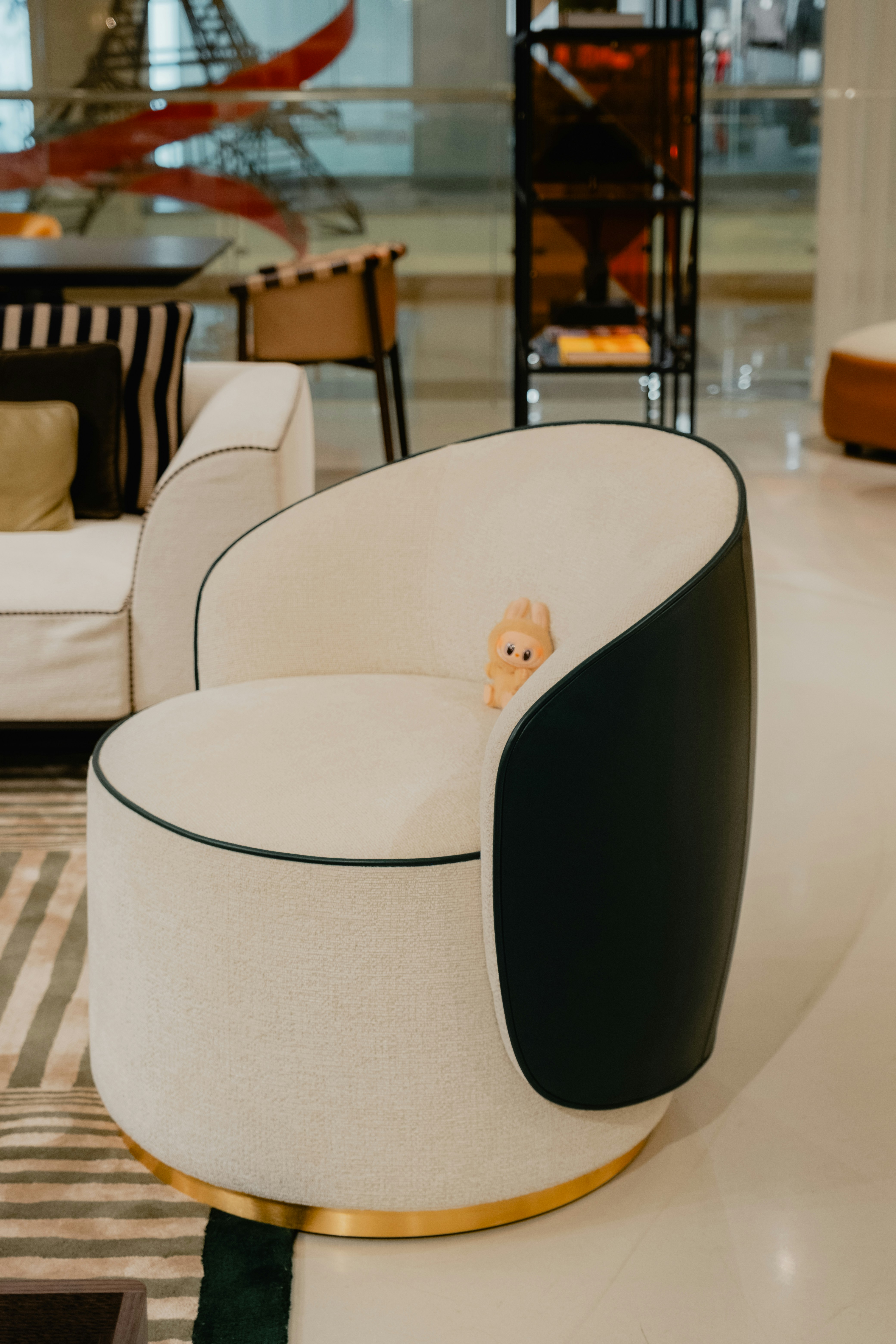 Whimsy at the Edge: A Circular Lounge Chair with a Tiny Observer