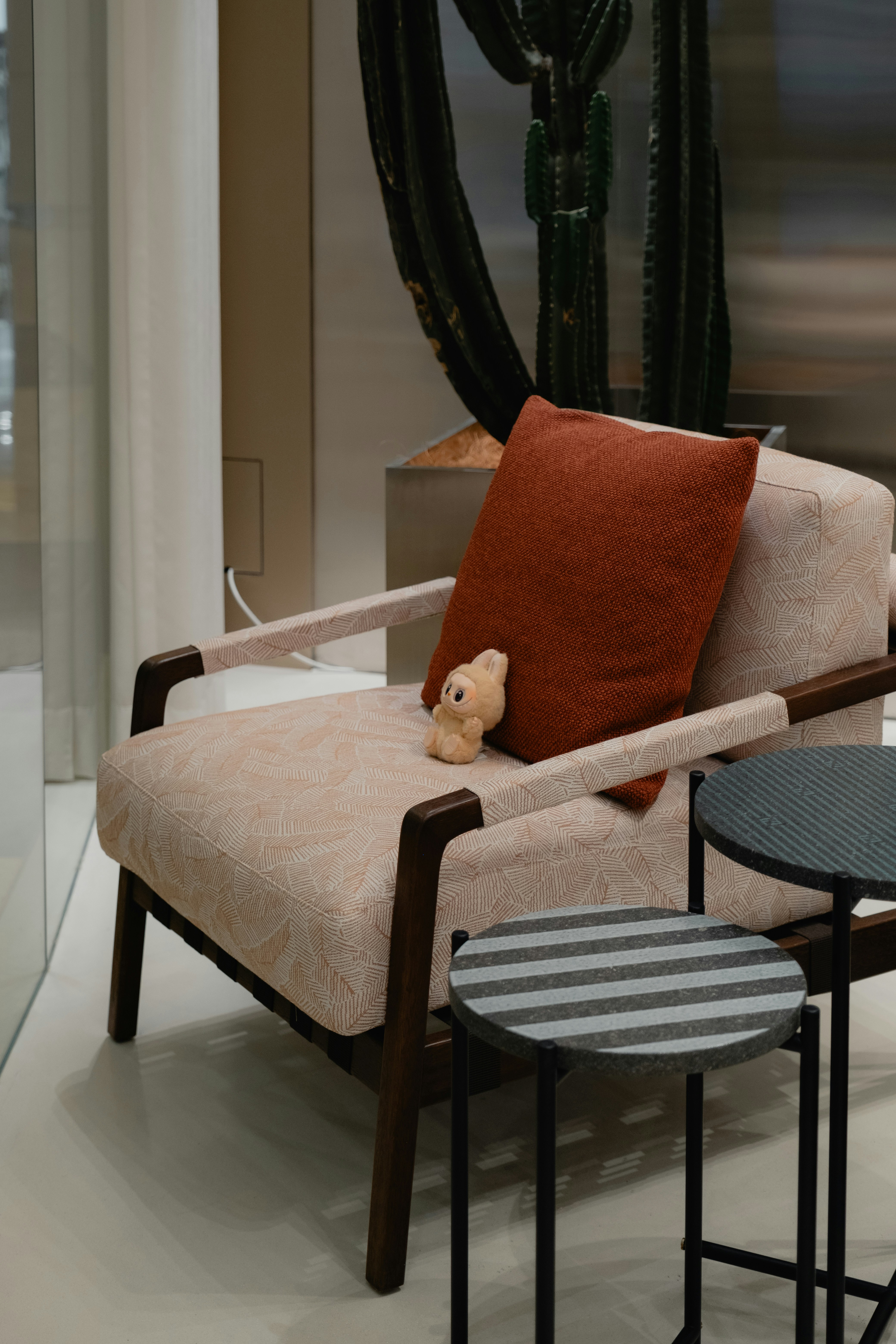 Tiny Bear on a Quiet Lounge: A Cozy Beige Chair Moment
