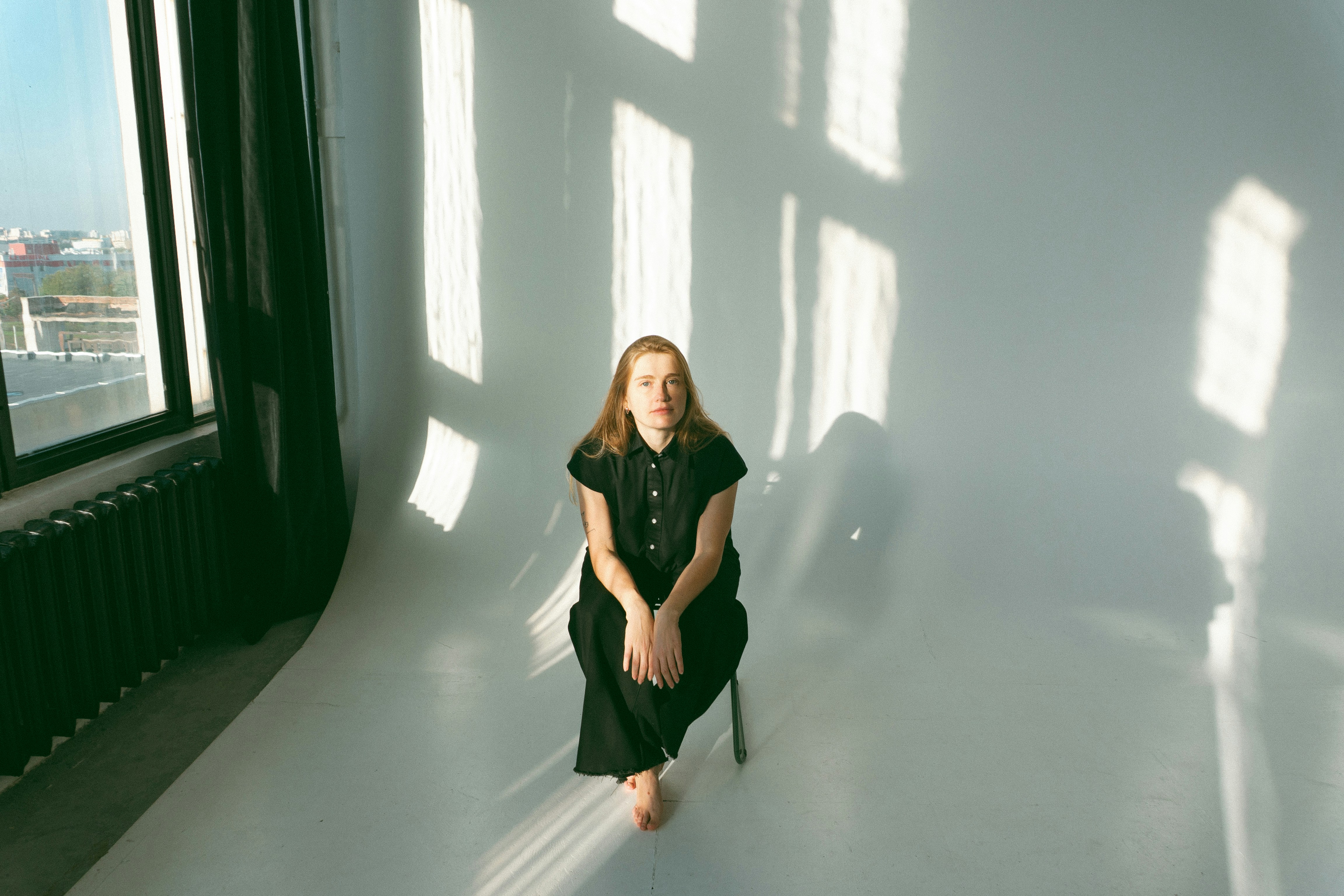 Barefoot in Light: A Calm Studio Portrait