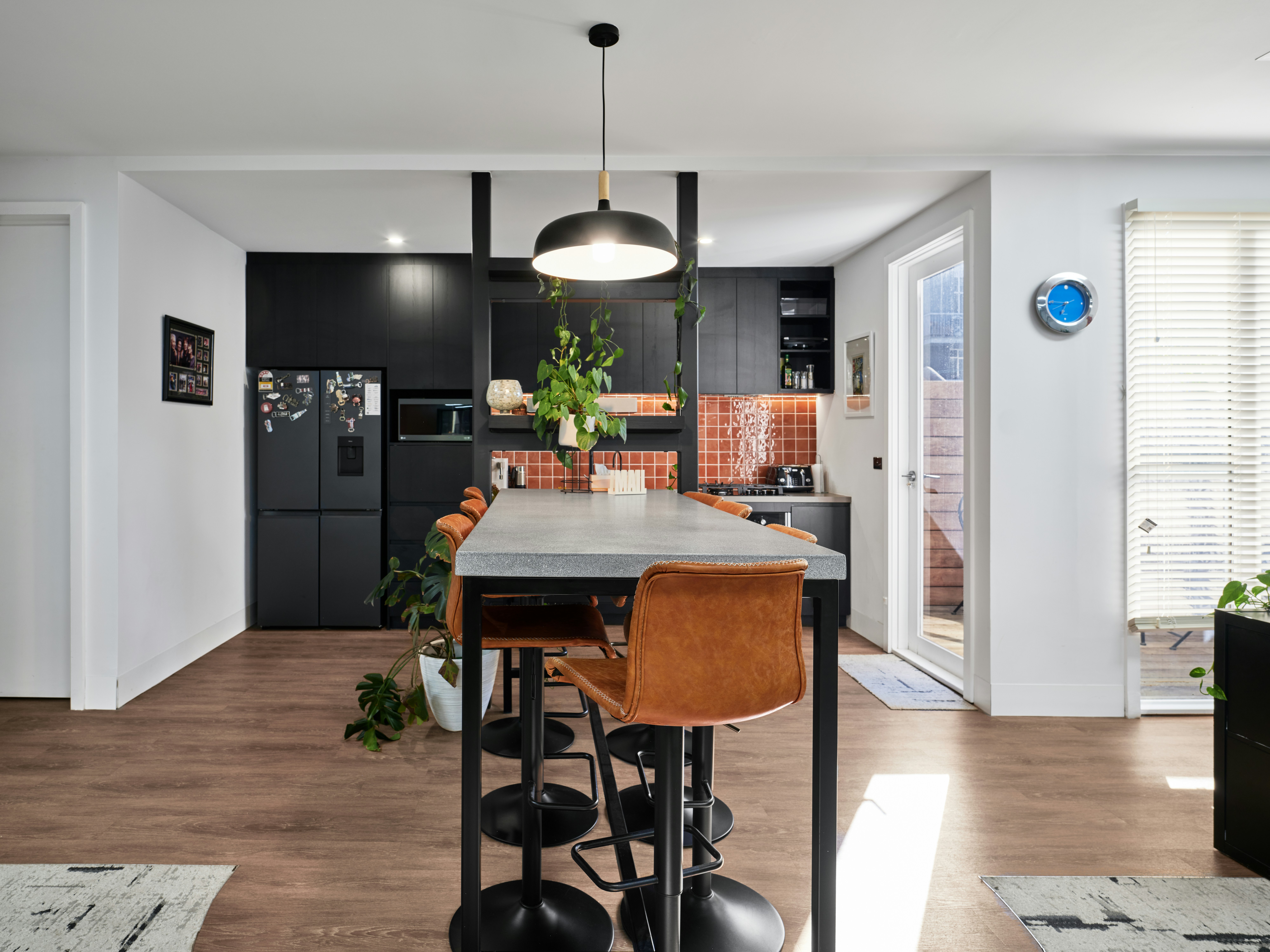A modern kitchen features a sleek black design. photo – Free Office ...