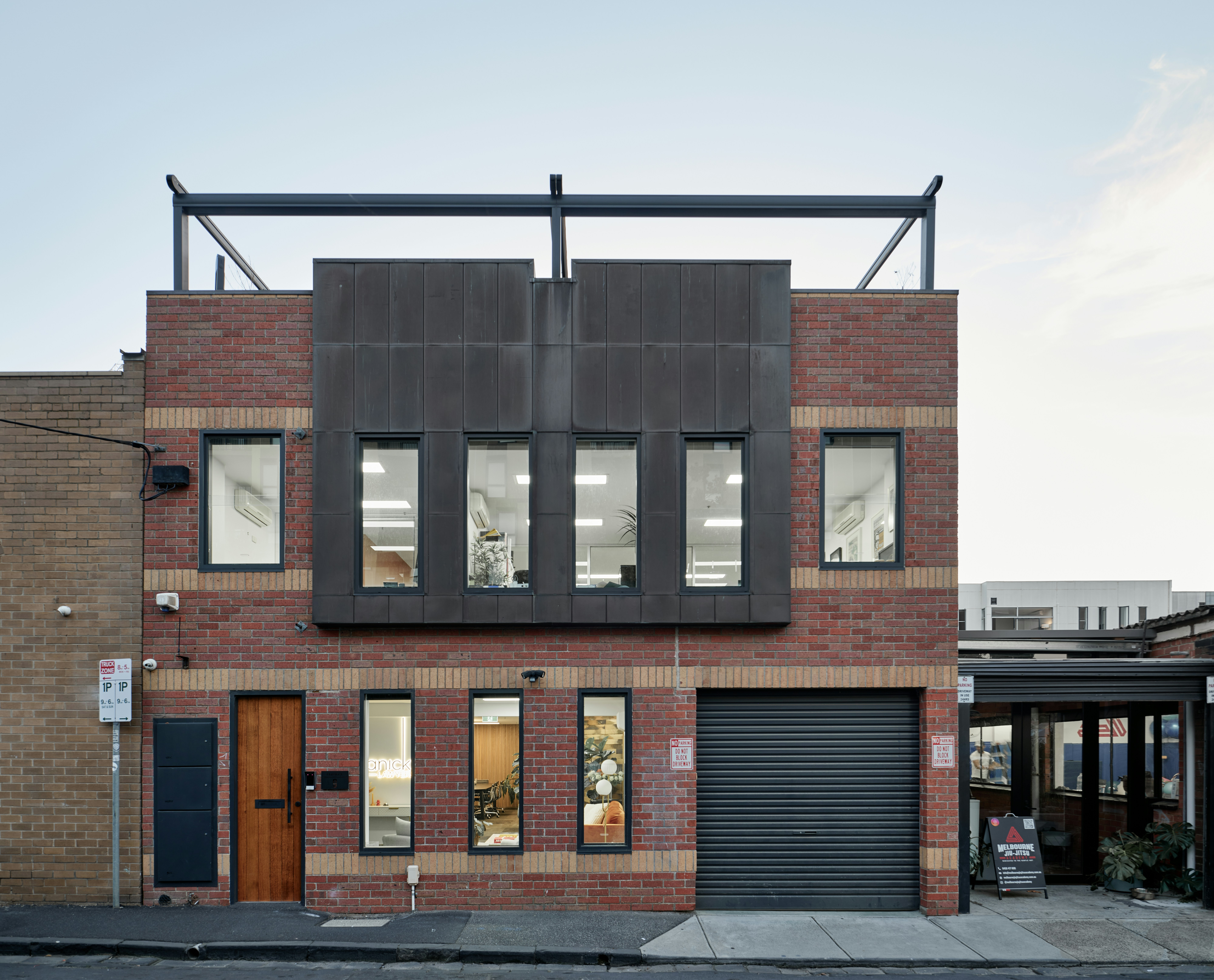 Modern brick building with dark panels and garage. photo – Free Office ...