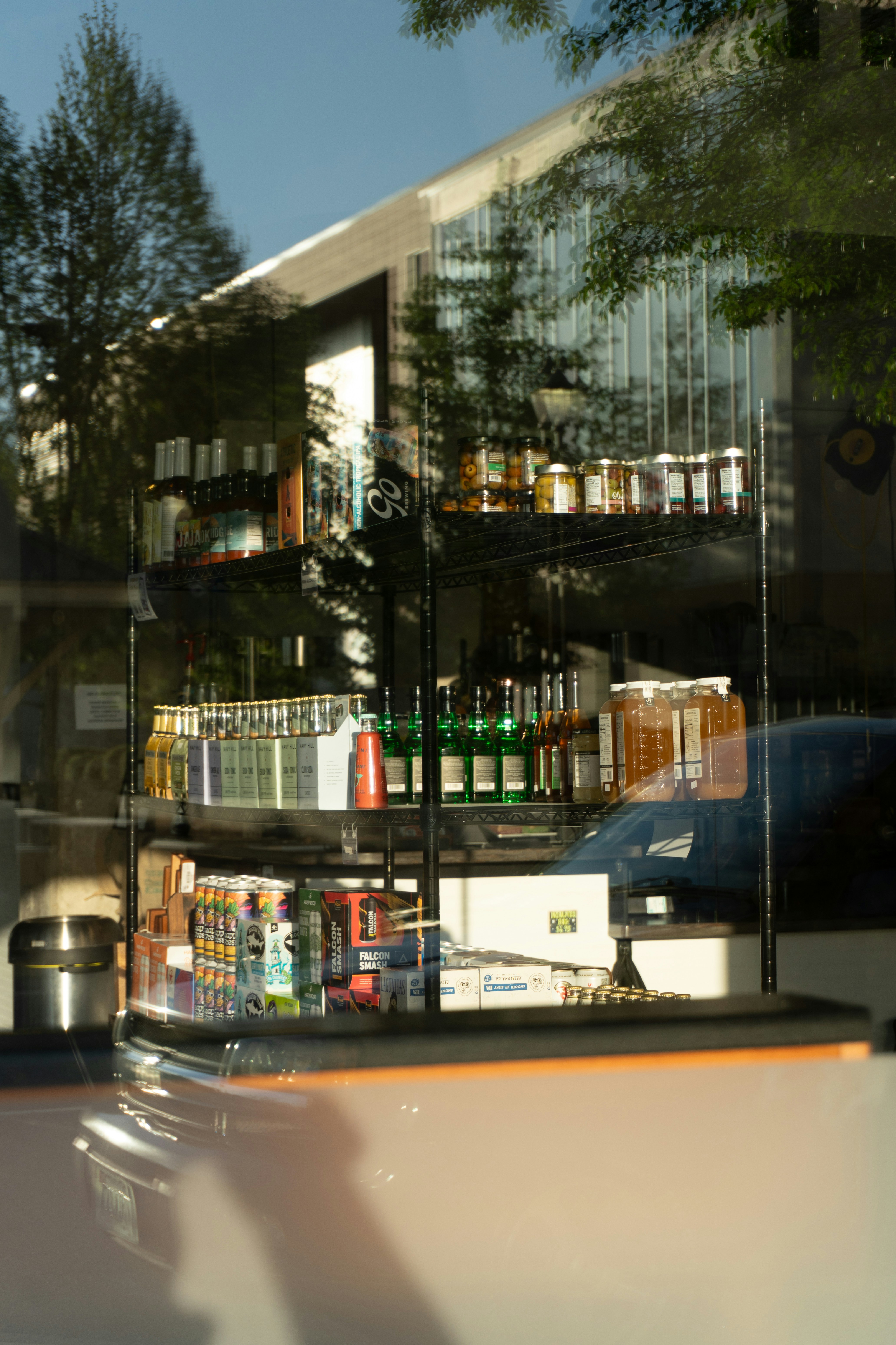 Shelves of goods are visible through a window. photo – Free City Image ...